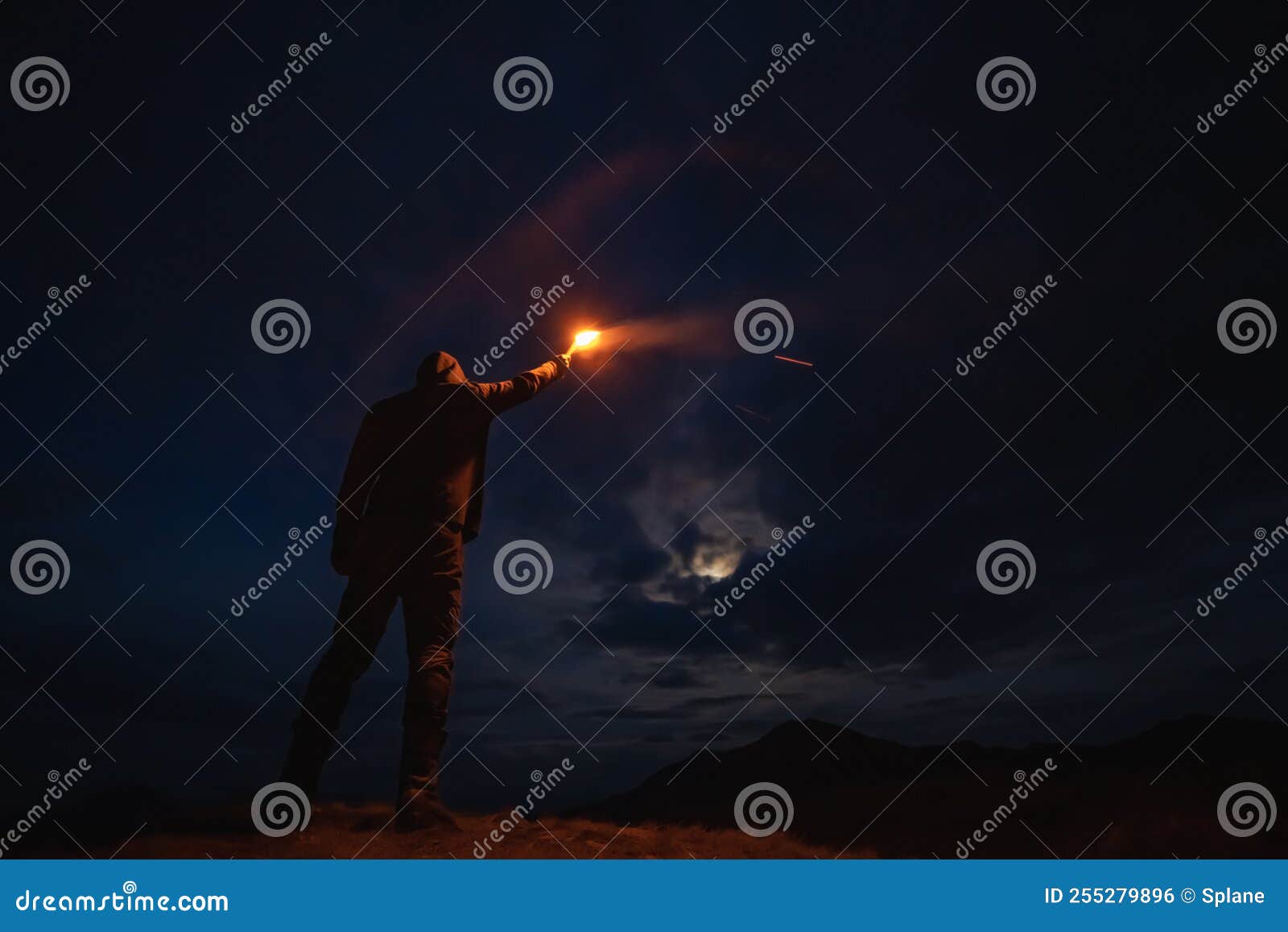 The Man with a Firework Stick Standing on the Night Mountain. Stock ...