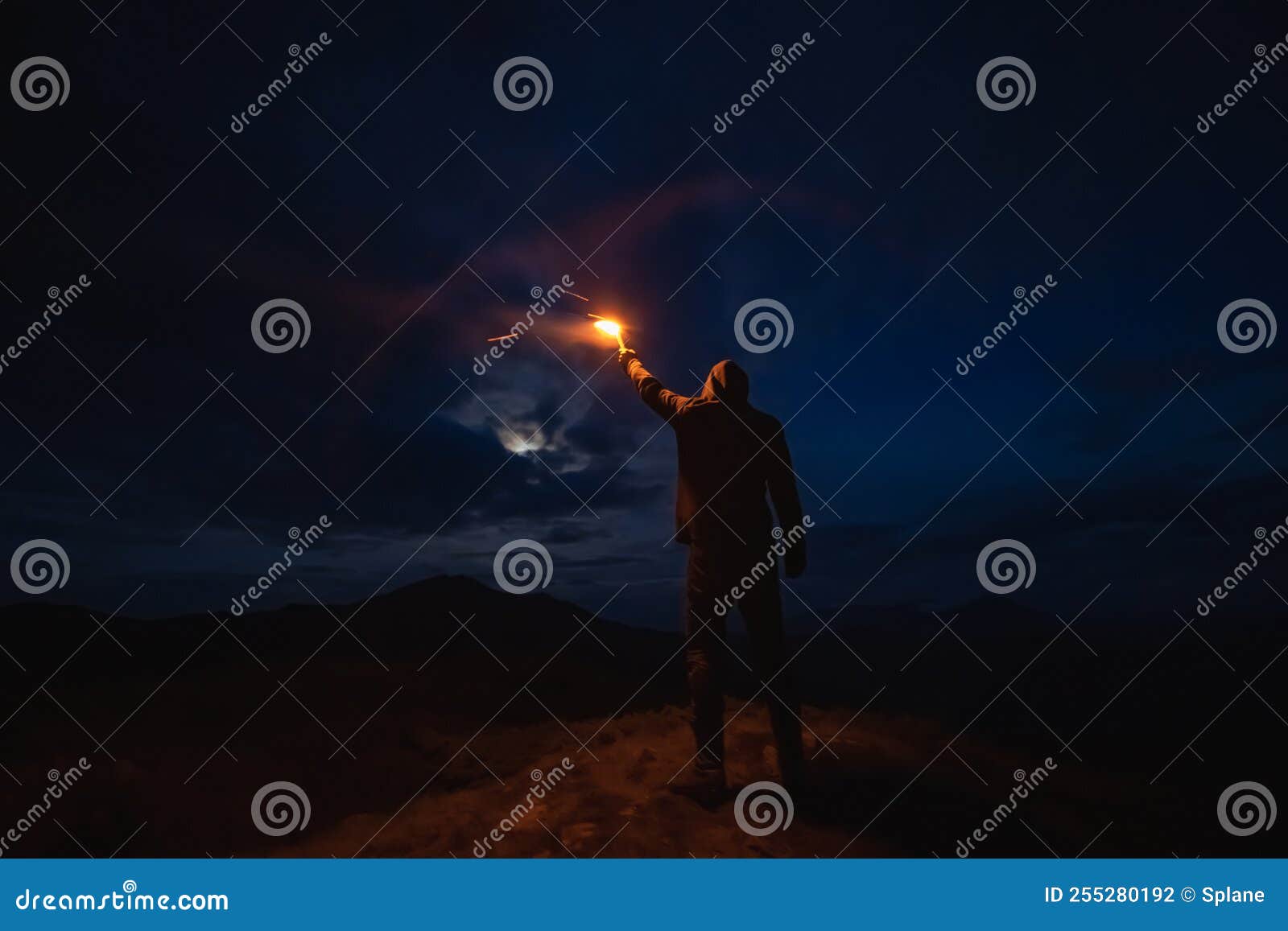 The Man with a Firework Stick Standing on the Night Mountain. Stock ...