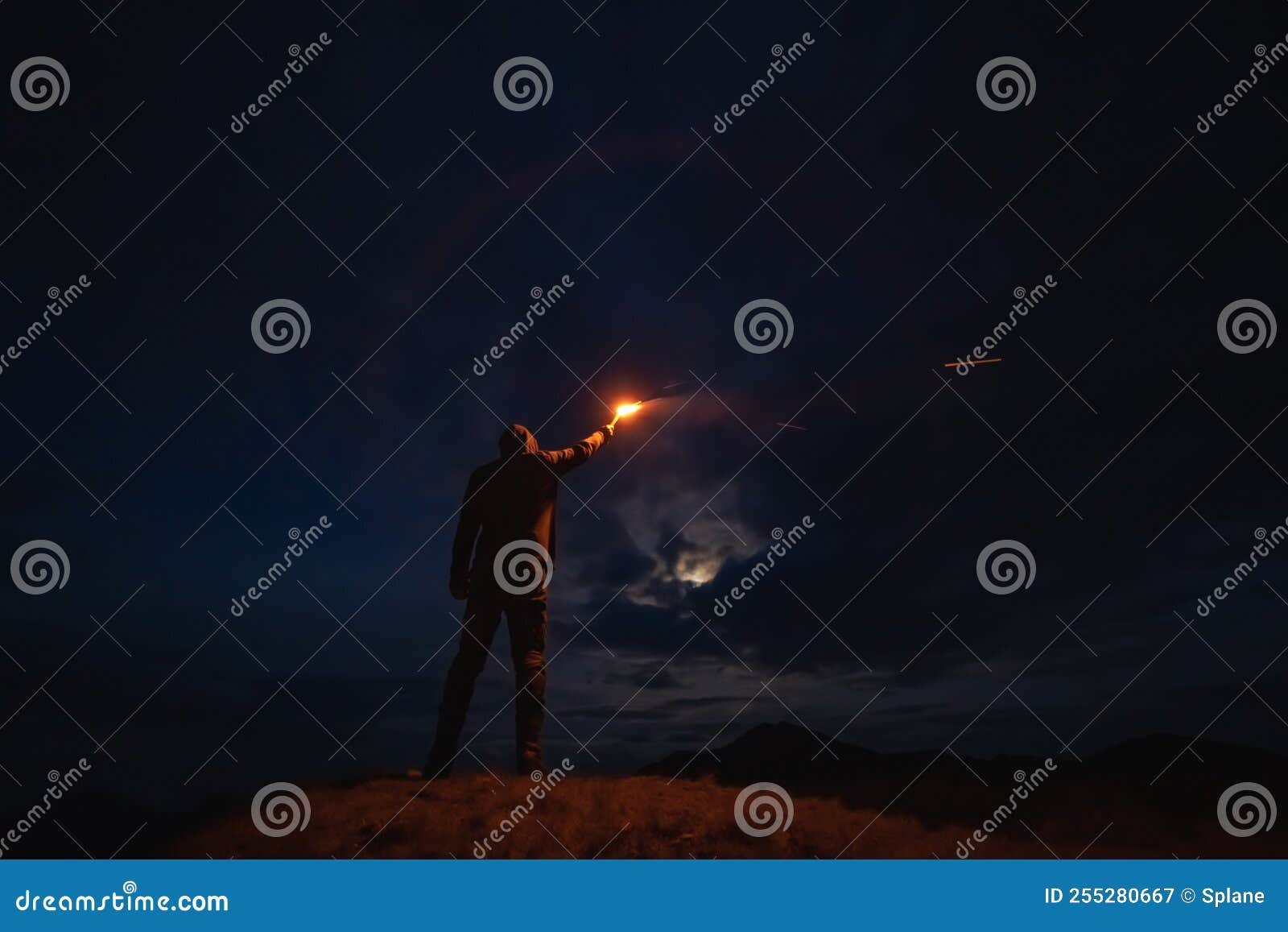 The Man with a Firework Stick Standing on the Night Mountain. Stock ...