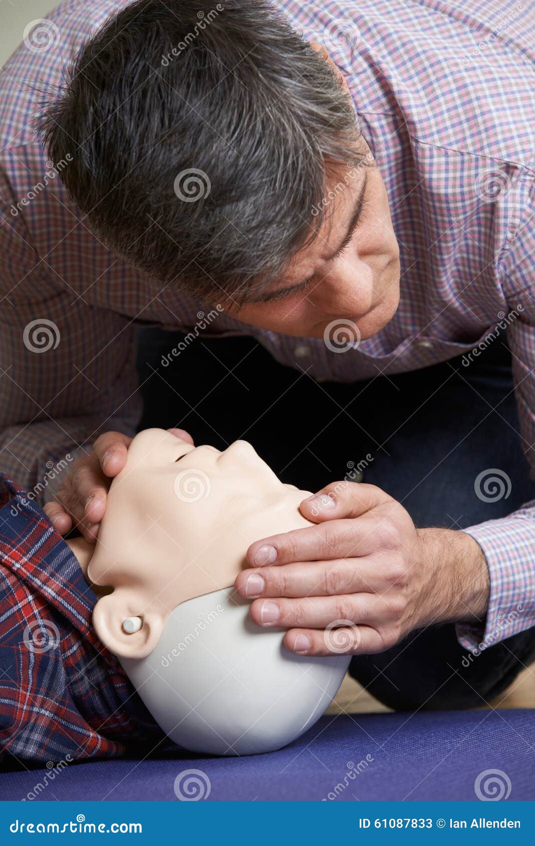 Man in First Aid Class Checking Airway on CPR Dummy Stock Image - Image ...
