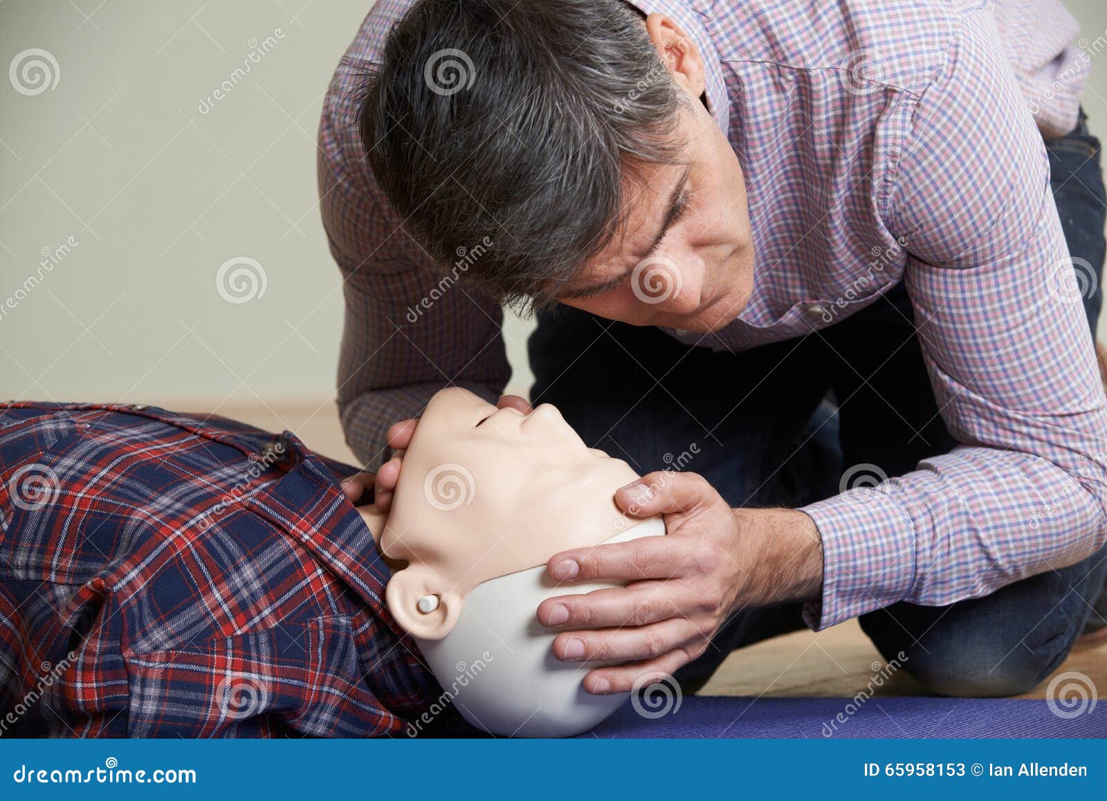 Man in First Aid Class Checking Airway on CPR Dummy Stock Image - Image ...