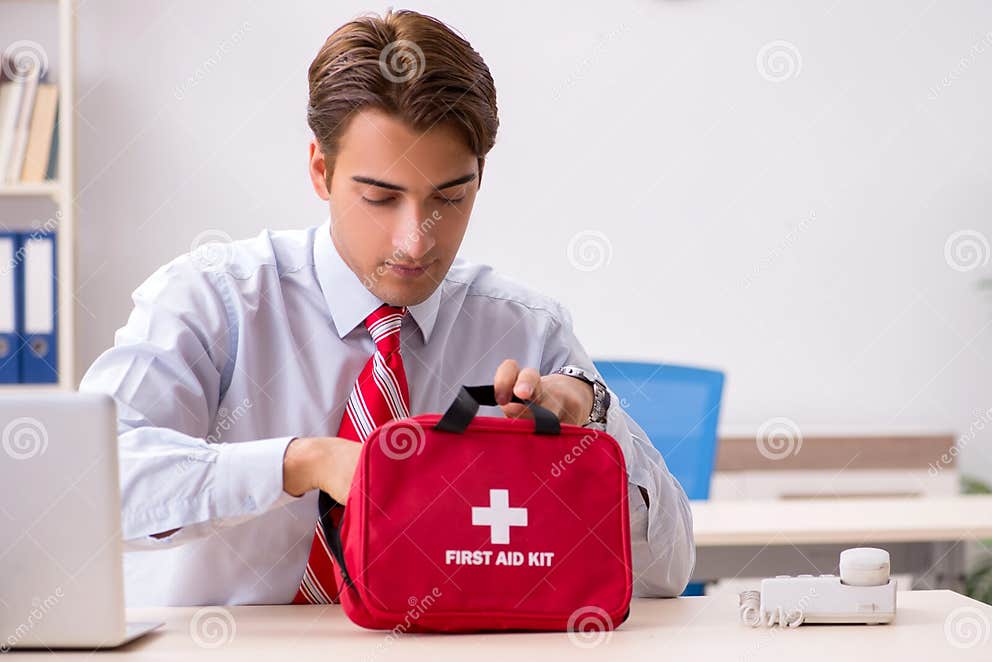The Man with First Aid Kit in the Office Stock Image - Image of desk ...