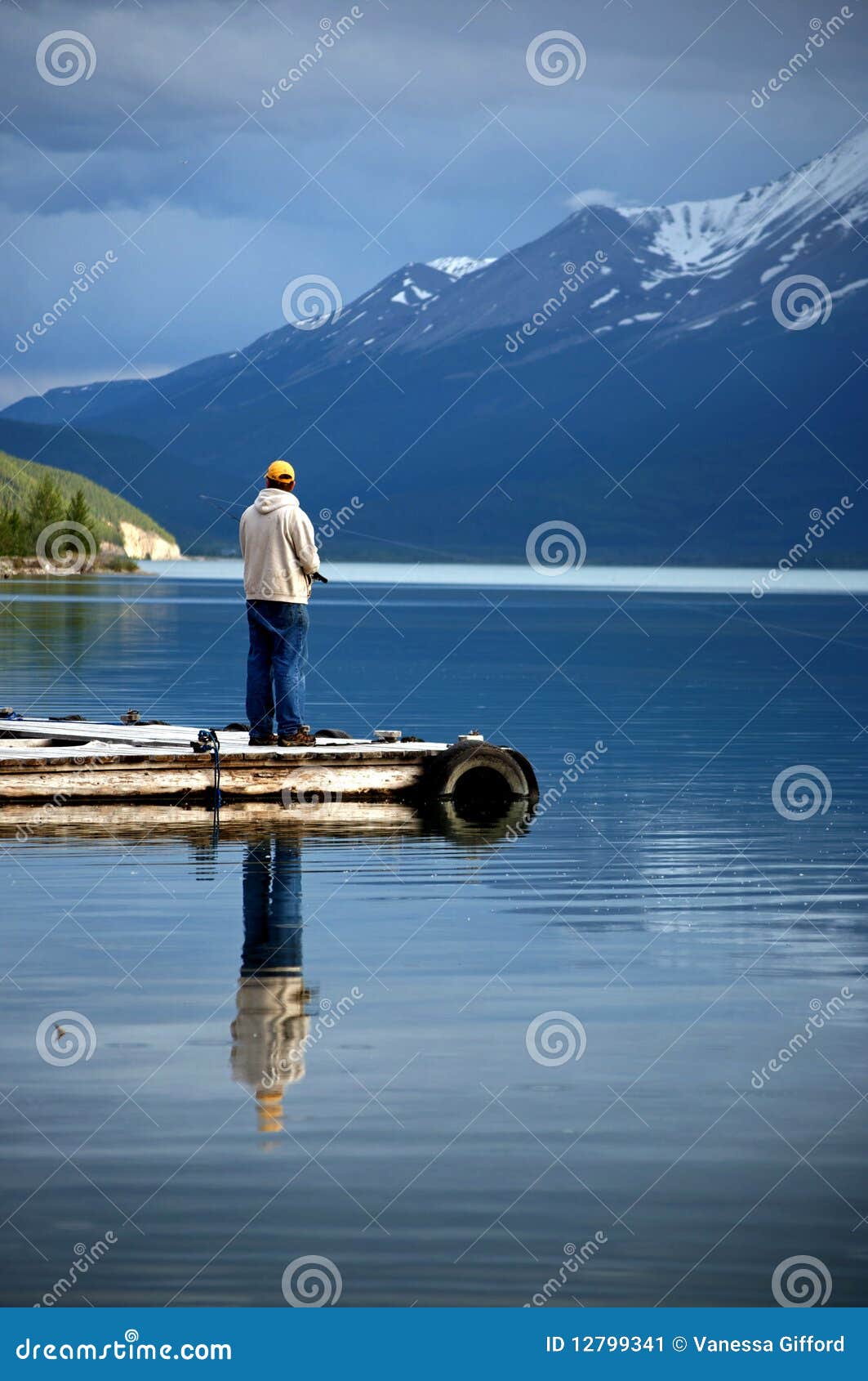 Man Fishing in an Alpine Lake Stock Image - Image of horizon, evening ...