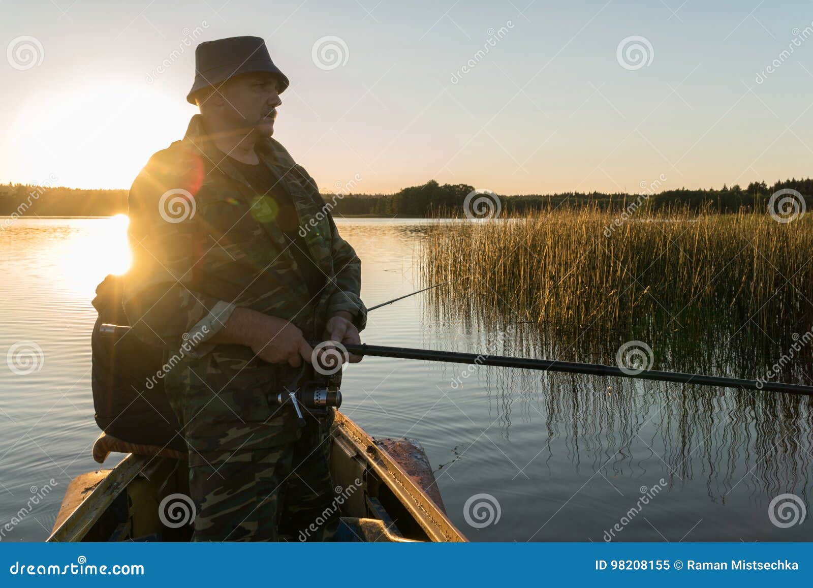 A Man is Fishing from a Boat on Sunset Stock Image - Image of lure ...