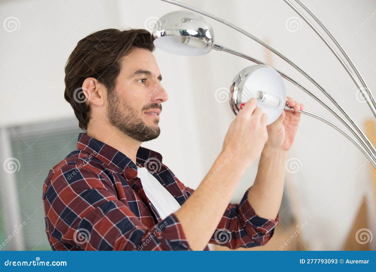 Man Fitting Bulb in Contemporary Light Stock Image - Image of indoor ...