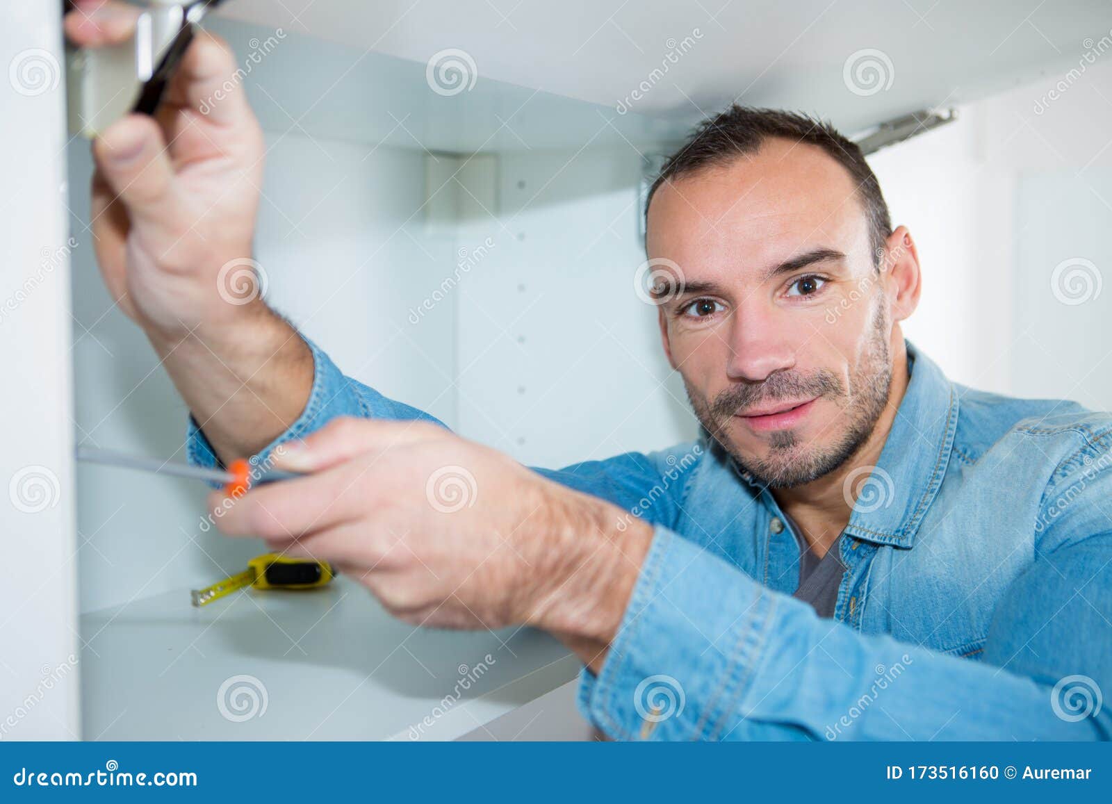 Man fitting cupboard stock photo. Image of handle, installation - 173516160