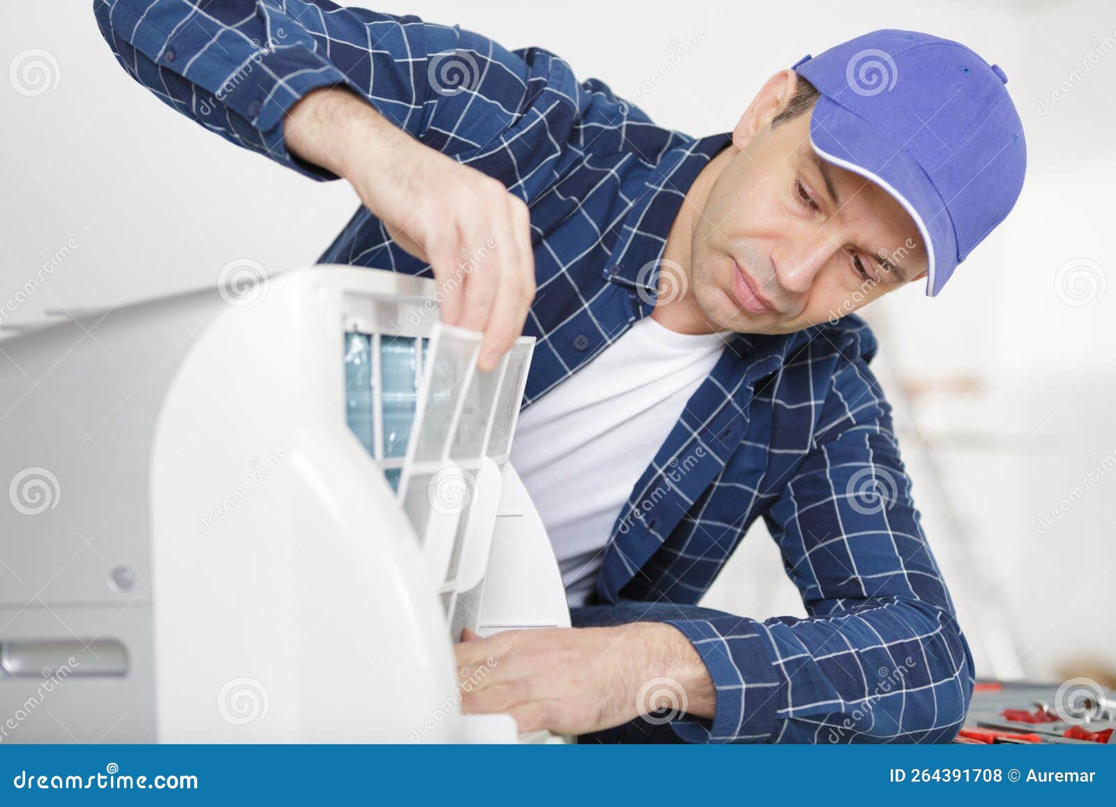 Man Fitting Grill on Air Conditioning Unit Stock Photo - Image of ...