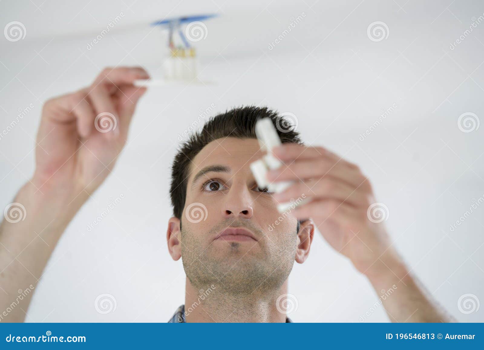 Man Fitting Light To Ceiling Stock Image - Image of light, installing ...