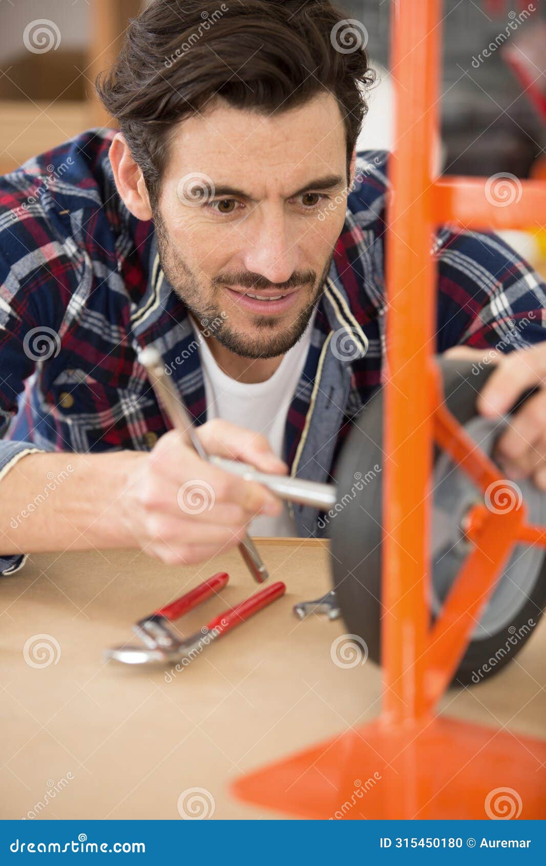 Man Fitting Casters on Trolley Stock Photo - Image of equipment, roller ...