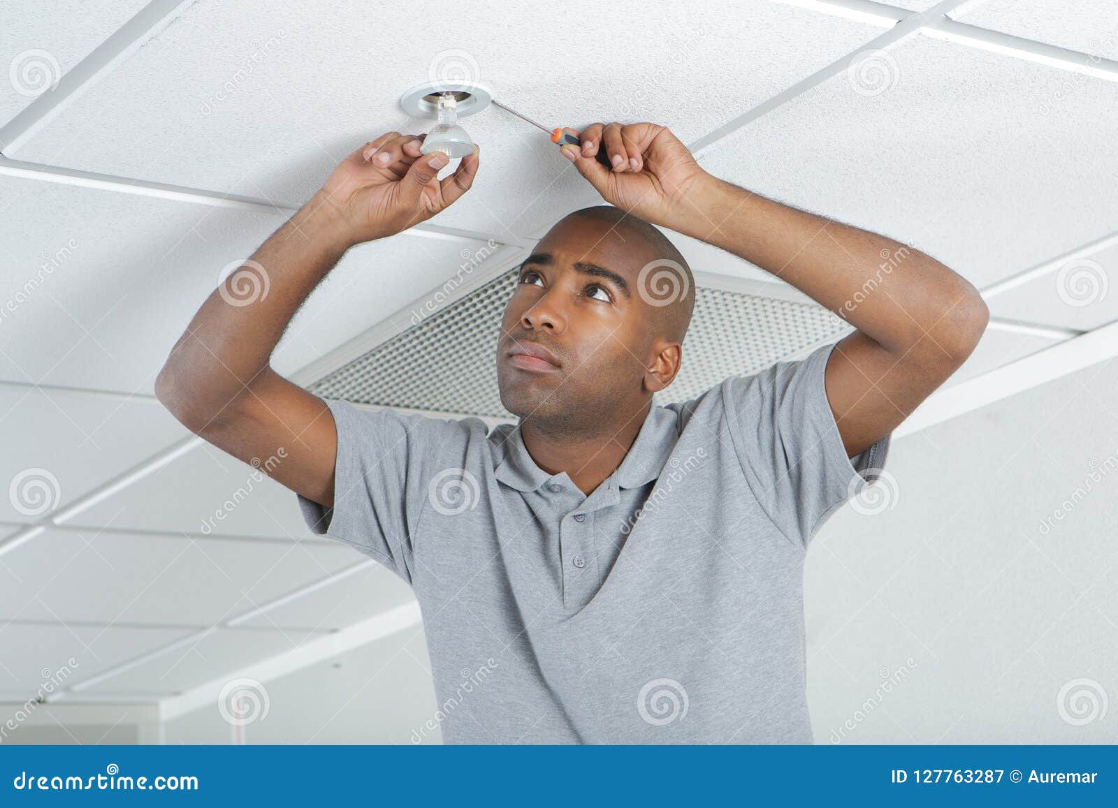 Man fitting spotlight bulb stock image. Image of light - 127763287