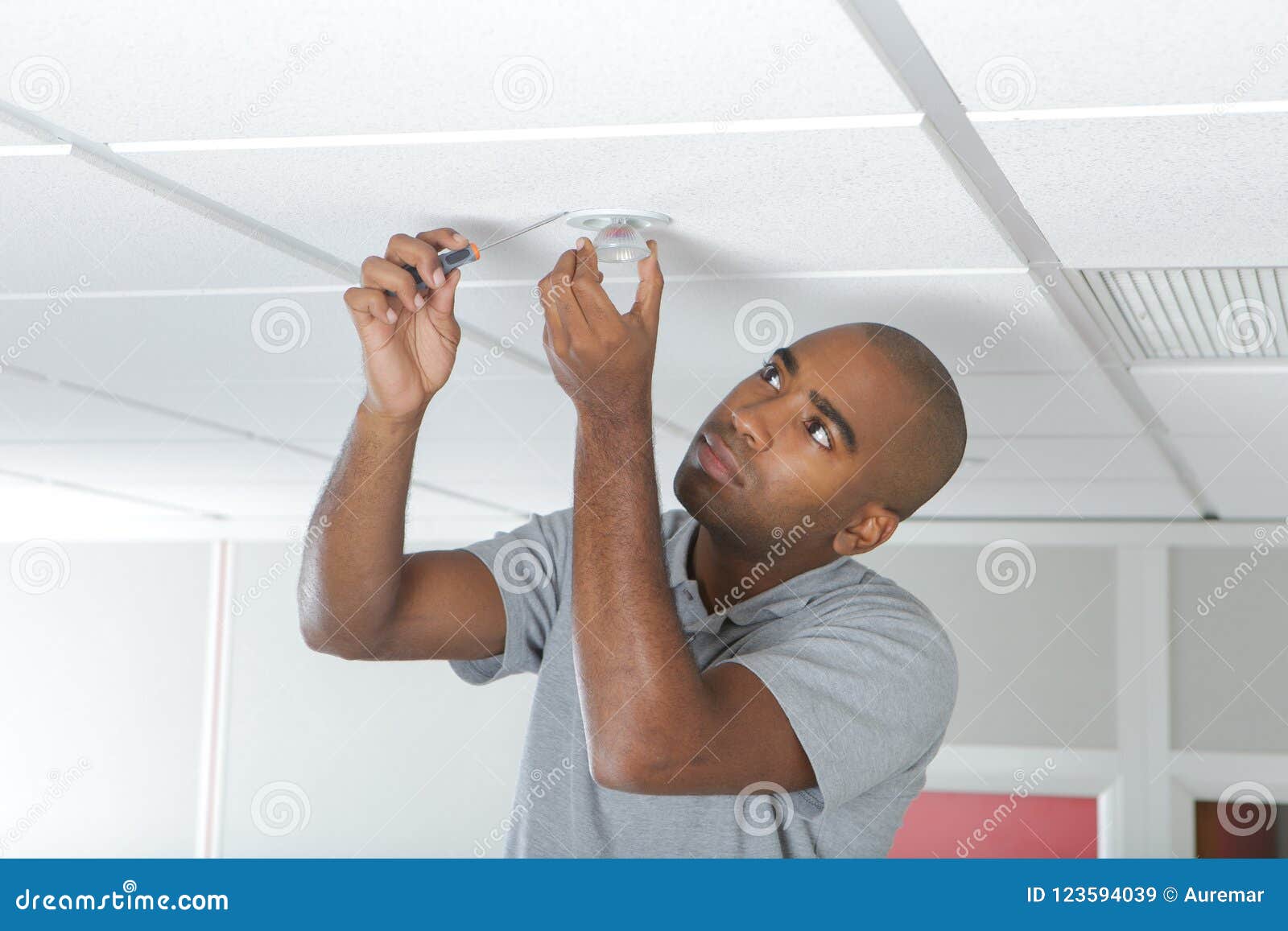 Man Fitting Spotlight To Ceiling Stock Image - Image of working, home ...