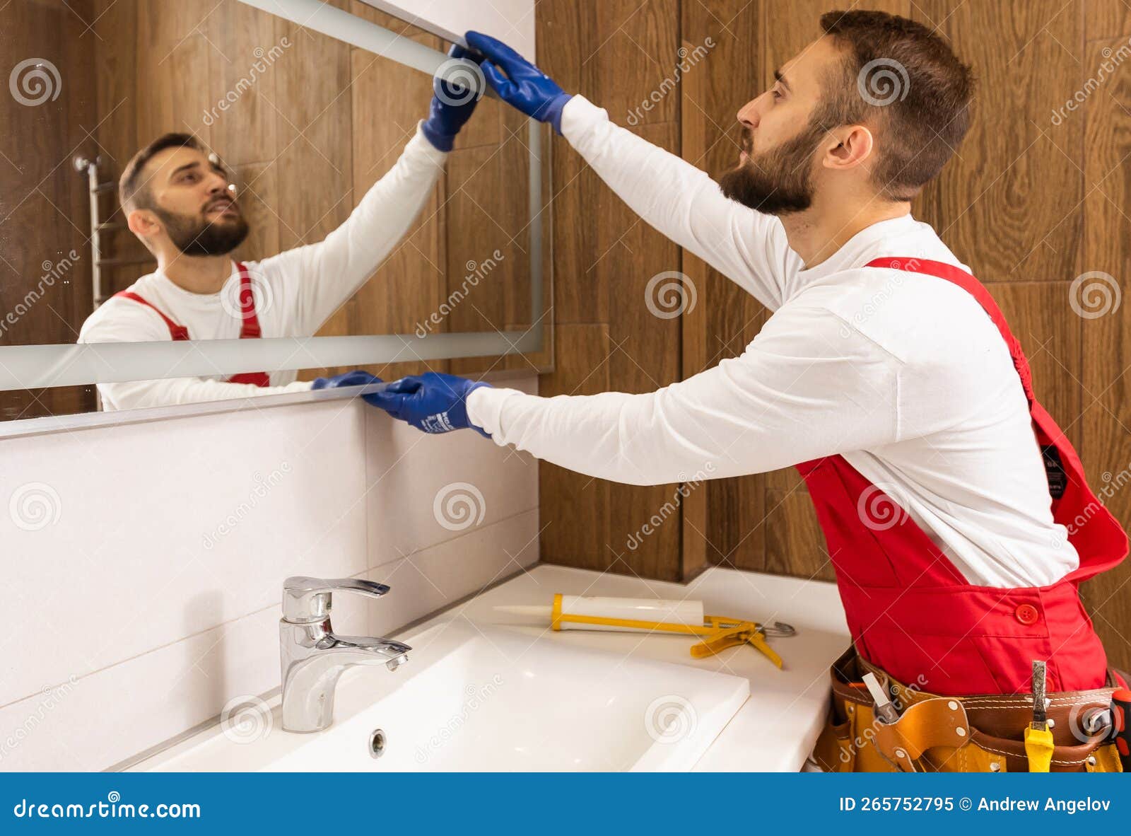 The man fixes the mirror stock image. Image of house - 265752795