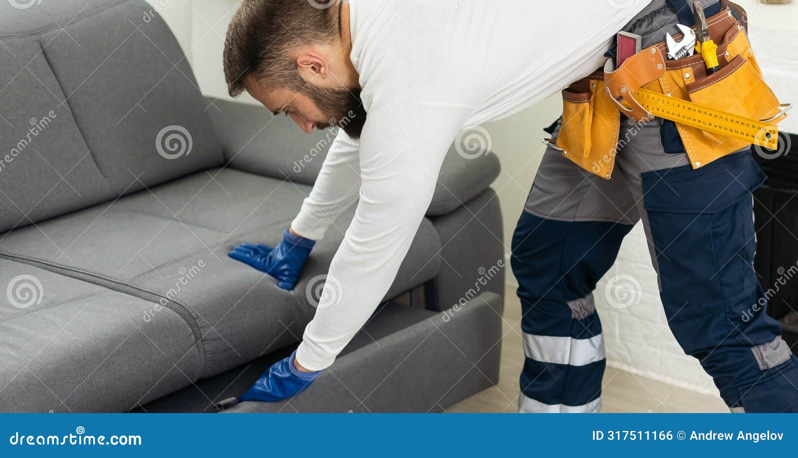 The man fixes the sofa. stock photo. Image of desk, assembling - 317511166
