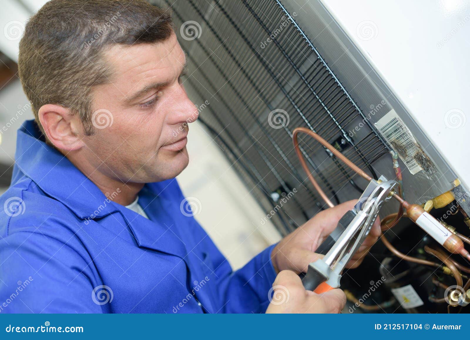 Man fixing appliances stock photo. Image of fridge, knowledge - 212517104