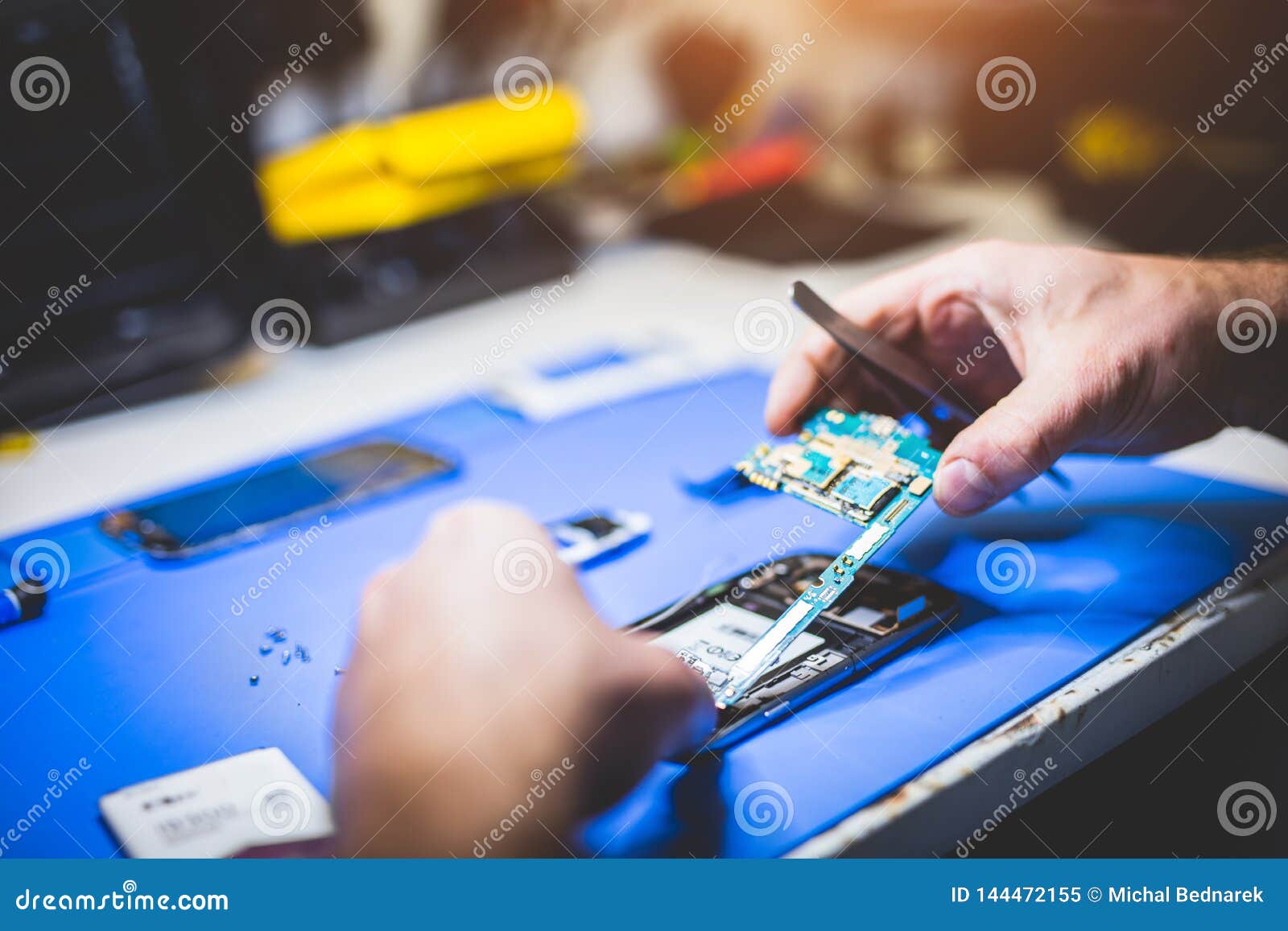 Man fixing a broken phone stock image. Image of electronic - 144472155