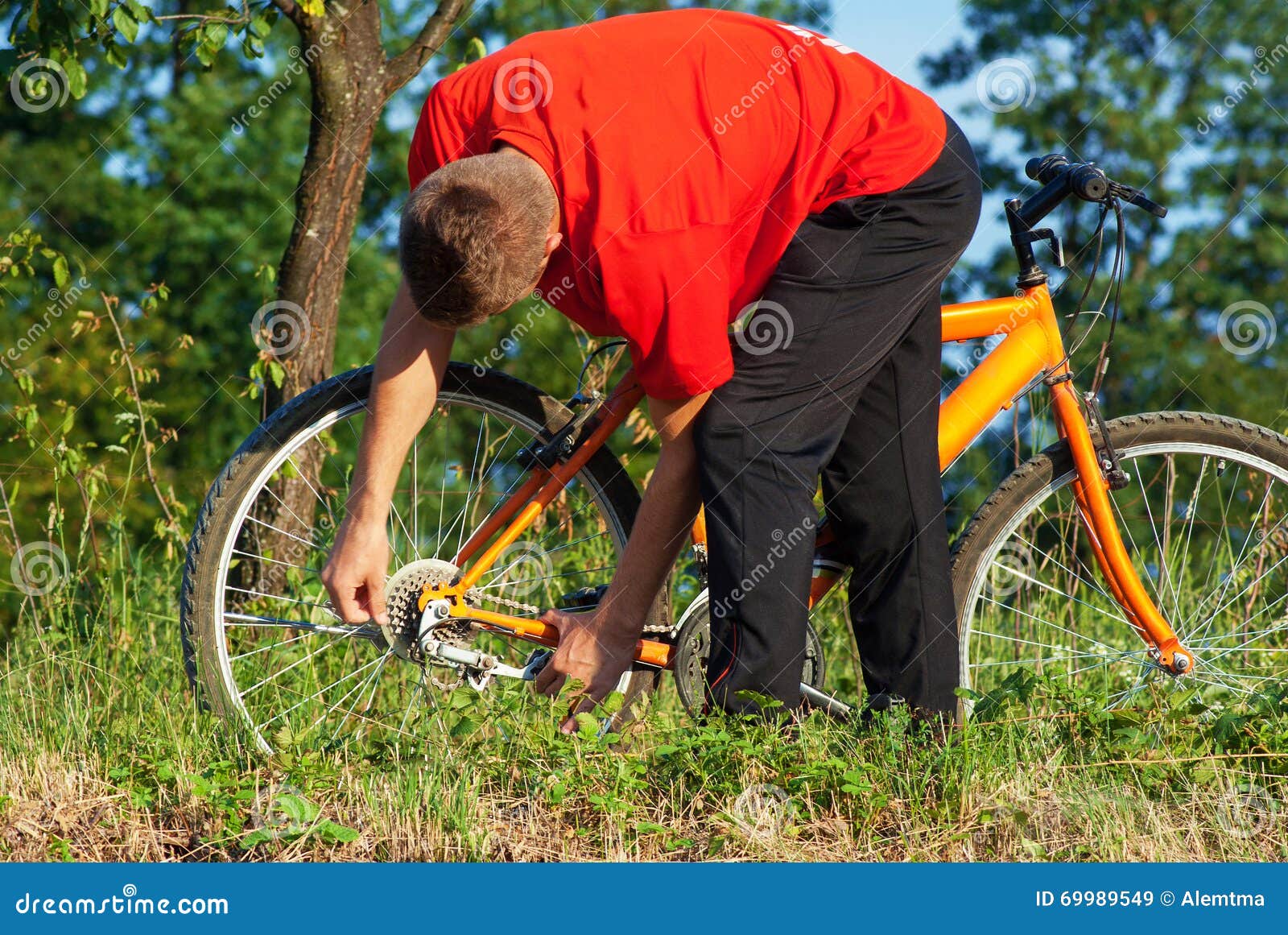 Man fixing bug on bike stock image. Image of nature, biker - 69989549