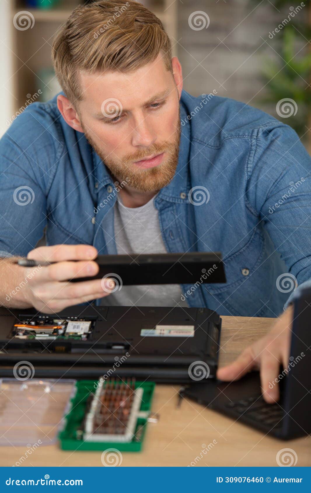 Man Fixing Circuit Board in Laptop Using Screwdriver Stock Photo ...