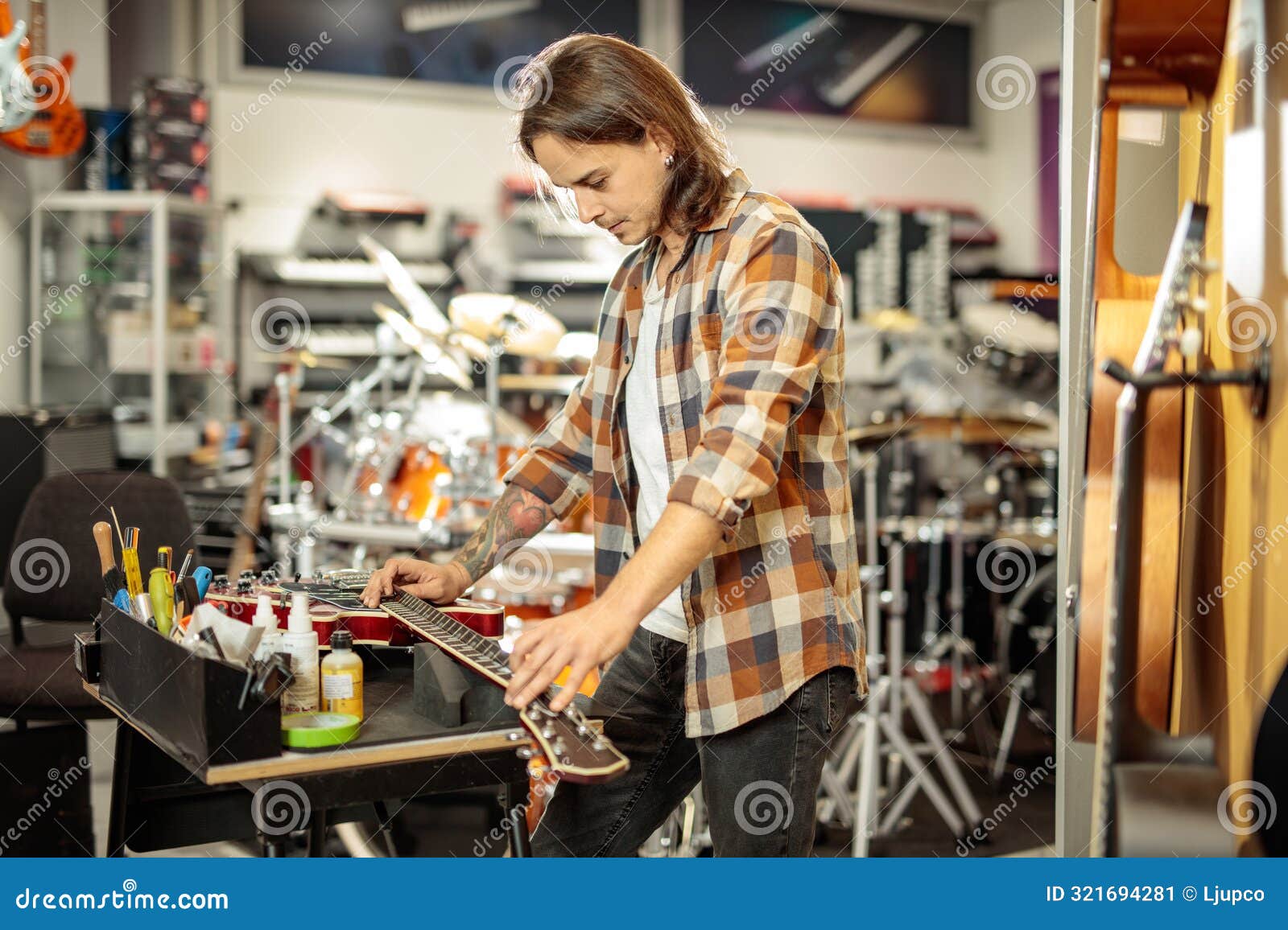 Man Fixing an Electric Guitar in a Workshop Stock Image - Image of ...