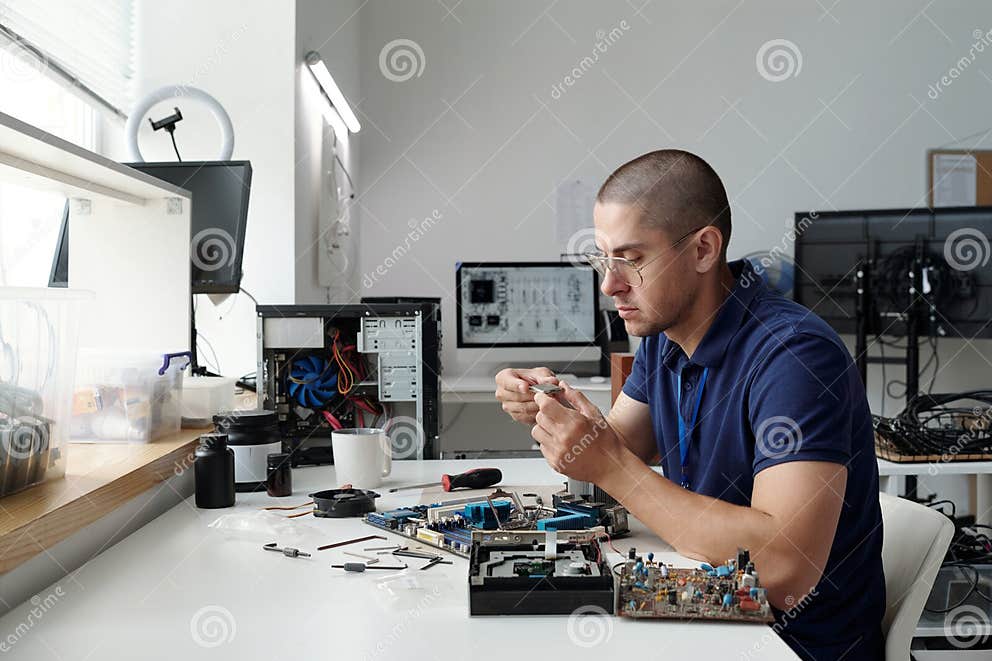 Man Fixing Electronic Device at Workbench Desk Stock Photo - Image of ...