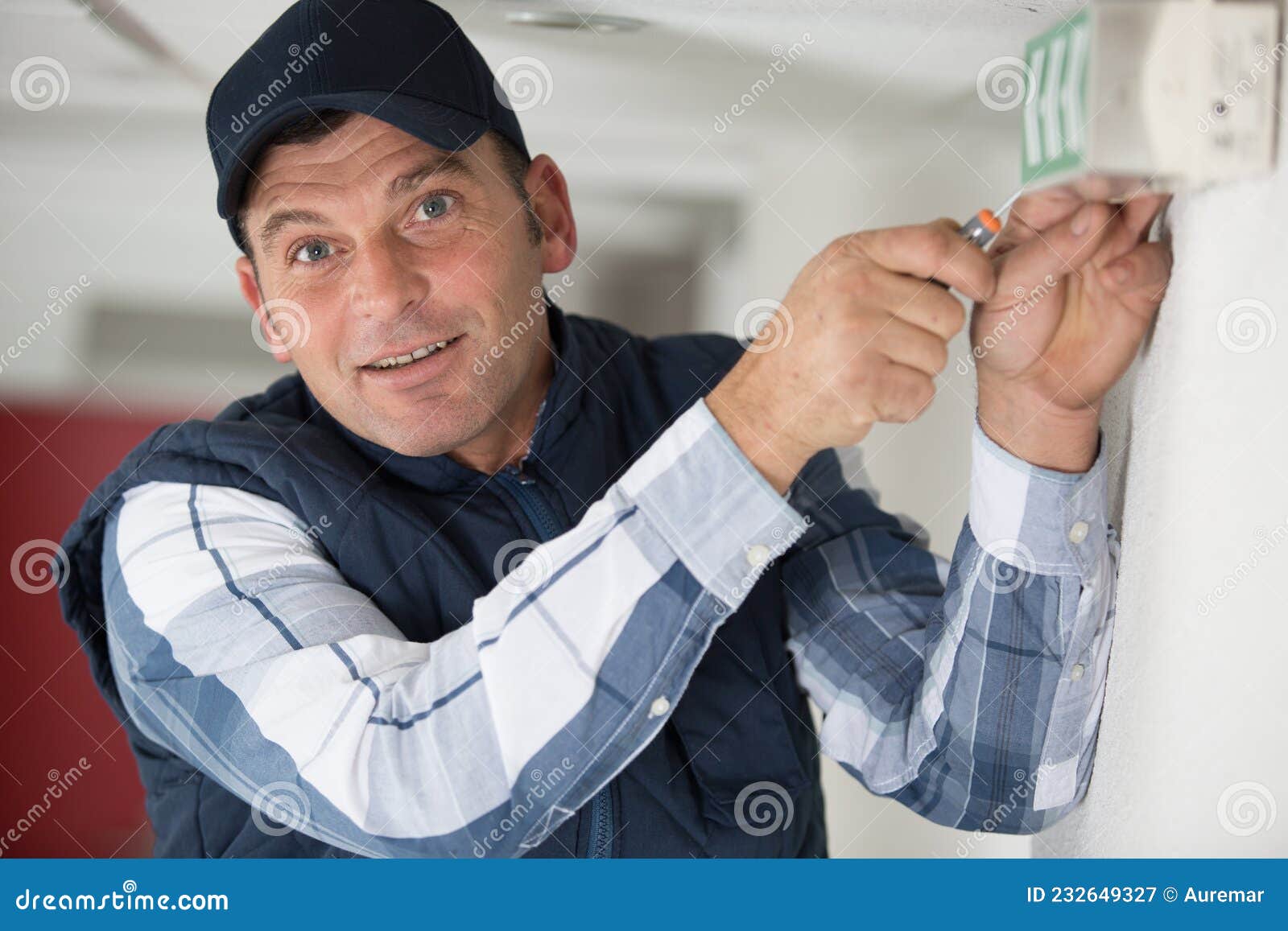 Man Fixing Exit Sign To Wall Stock Image - Image of accident, male ...