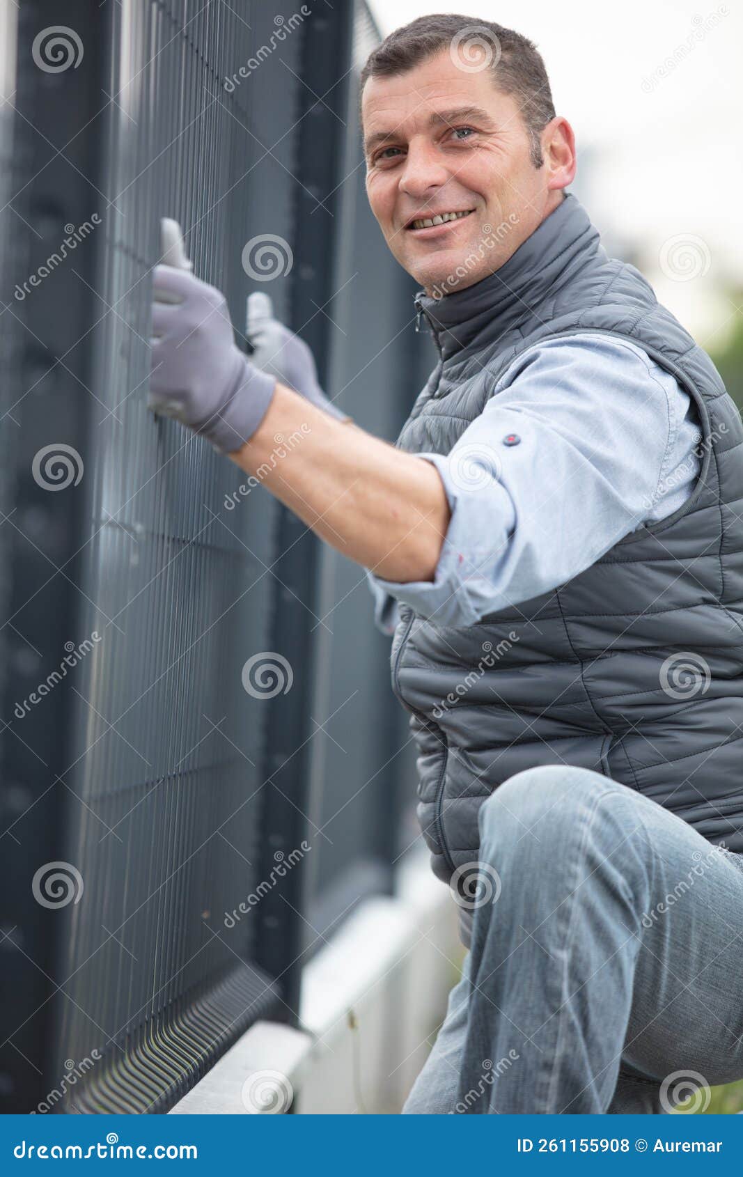 Man fixing fence outdoors stock photo. Image of happy - 261155908
