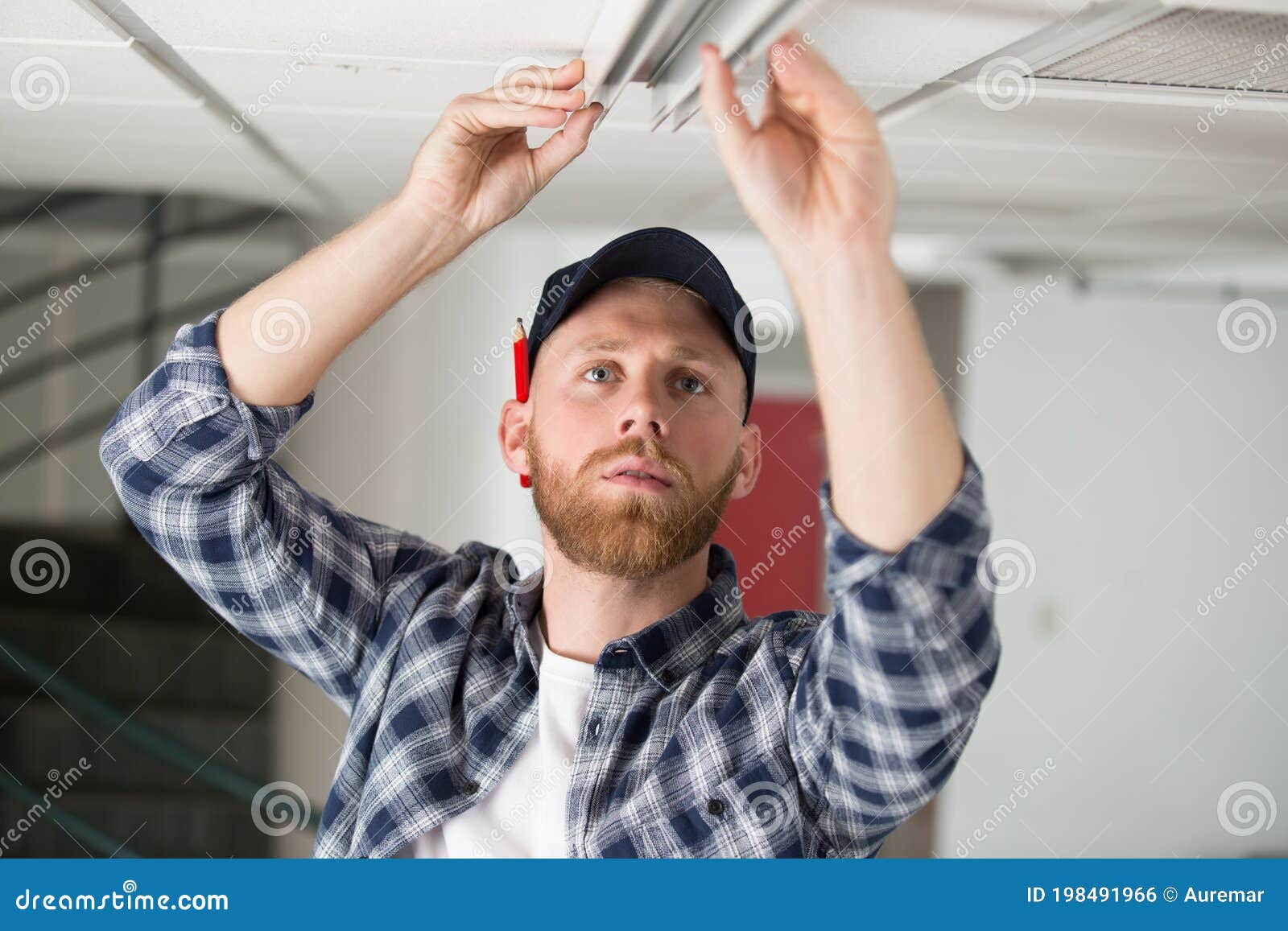 Man fixing light at home stock photo. Image of professional - 198491966