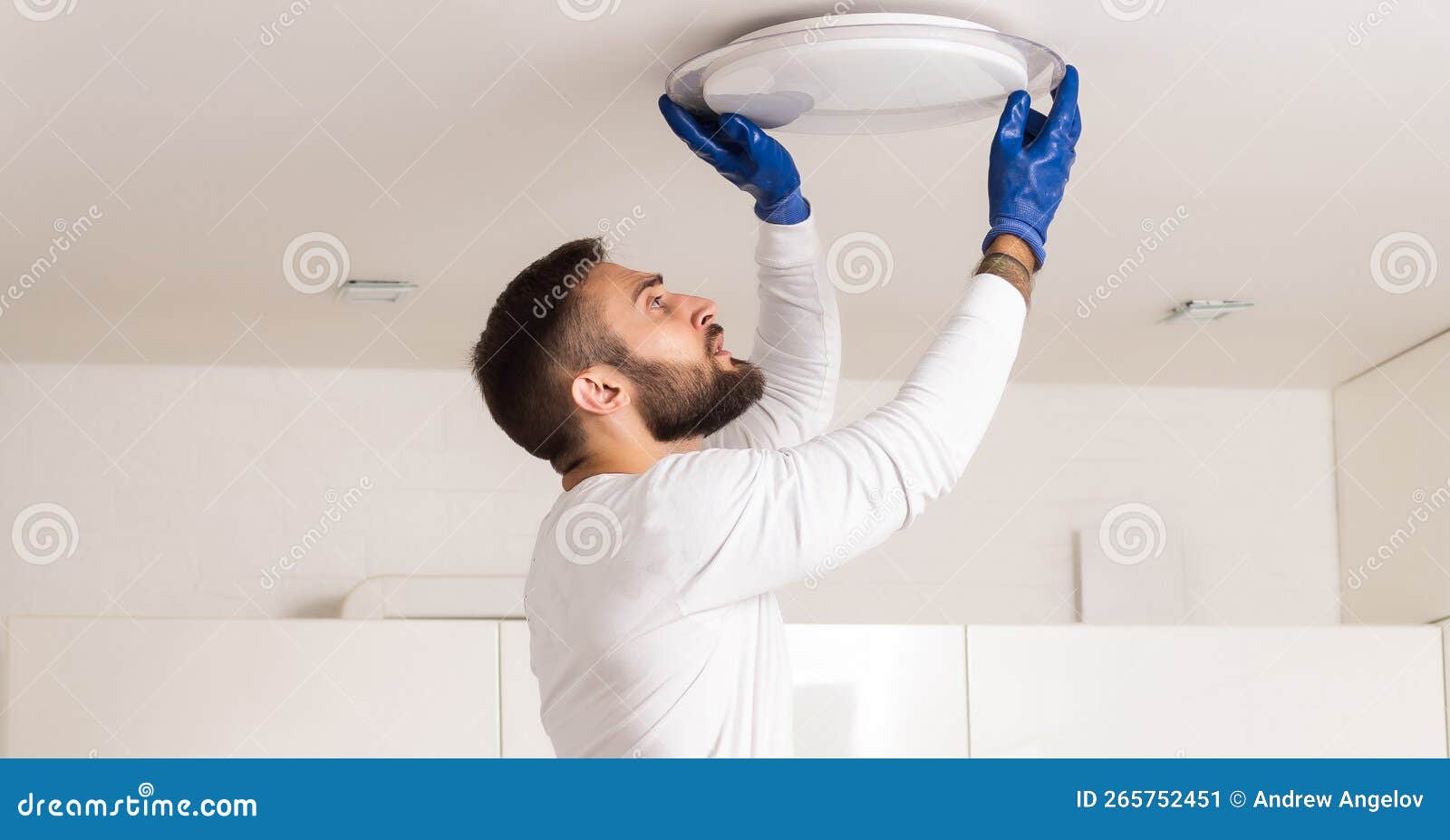 Man Fixing Light at Home. stock image. Image of happy - 265752451