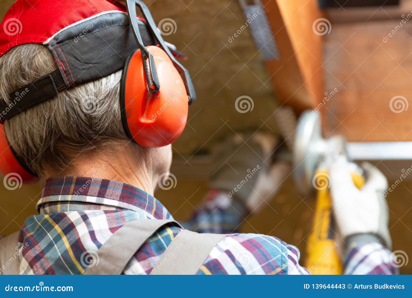 Man Fixing Metal Frame Using Angle Grinder on Attic Ceiling Covered ...