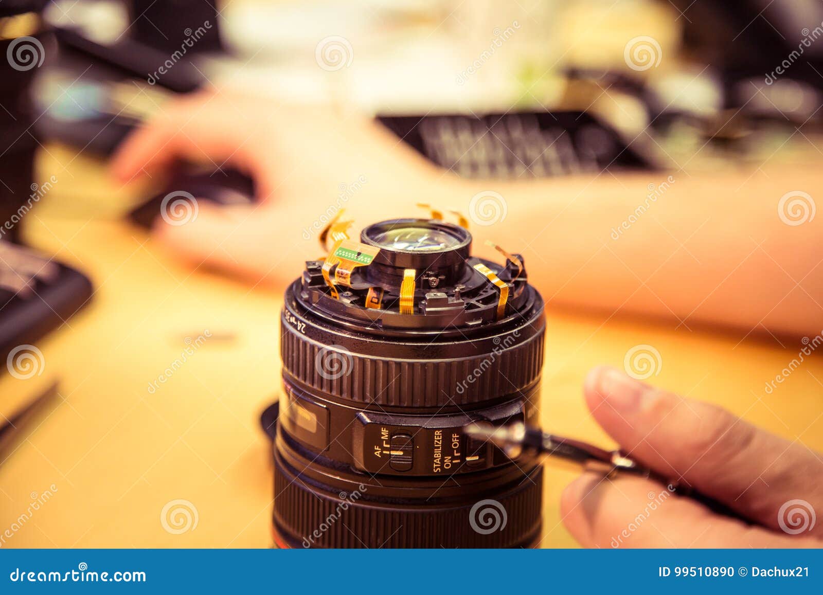 A Man Fixing Photo Camera Lens on an Office Table Stock Photo - Image ...