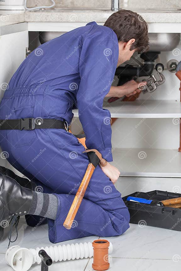 Man fixing pipe stock image. Image of plumbing, contractor - 74303375