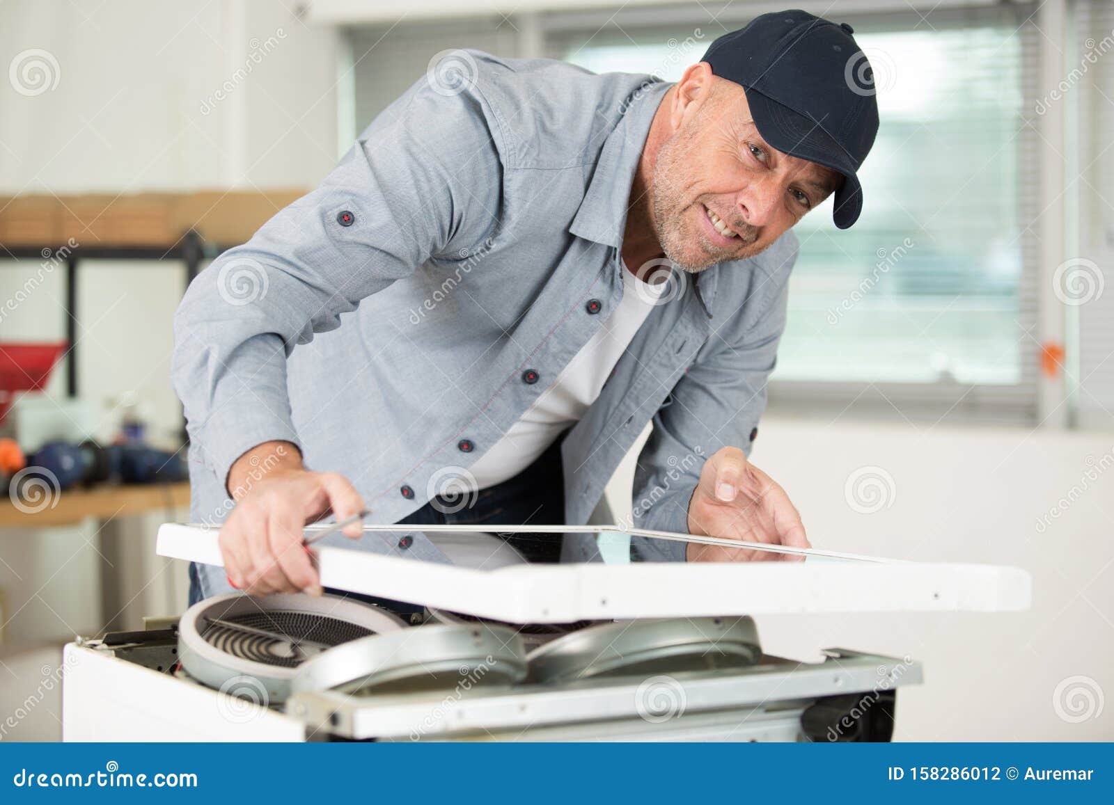 Man Fixing Something in Kitchen Stock Photo - Image of caucasian, hand ...