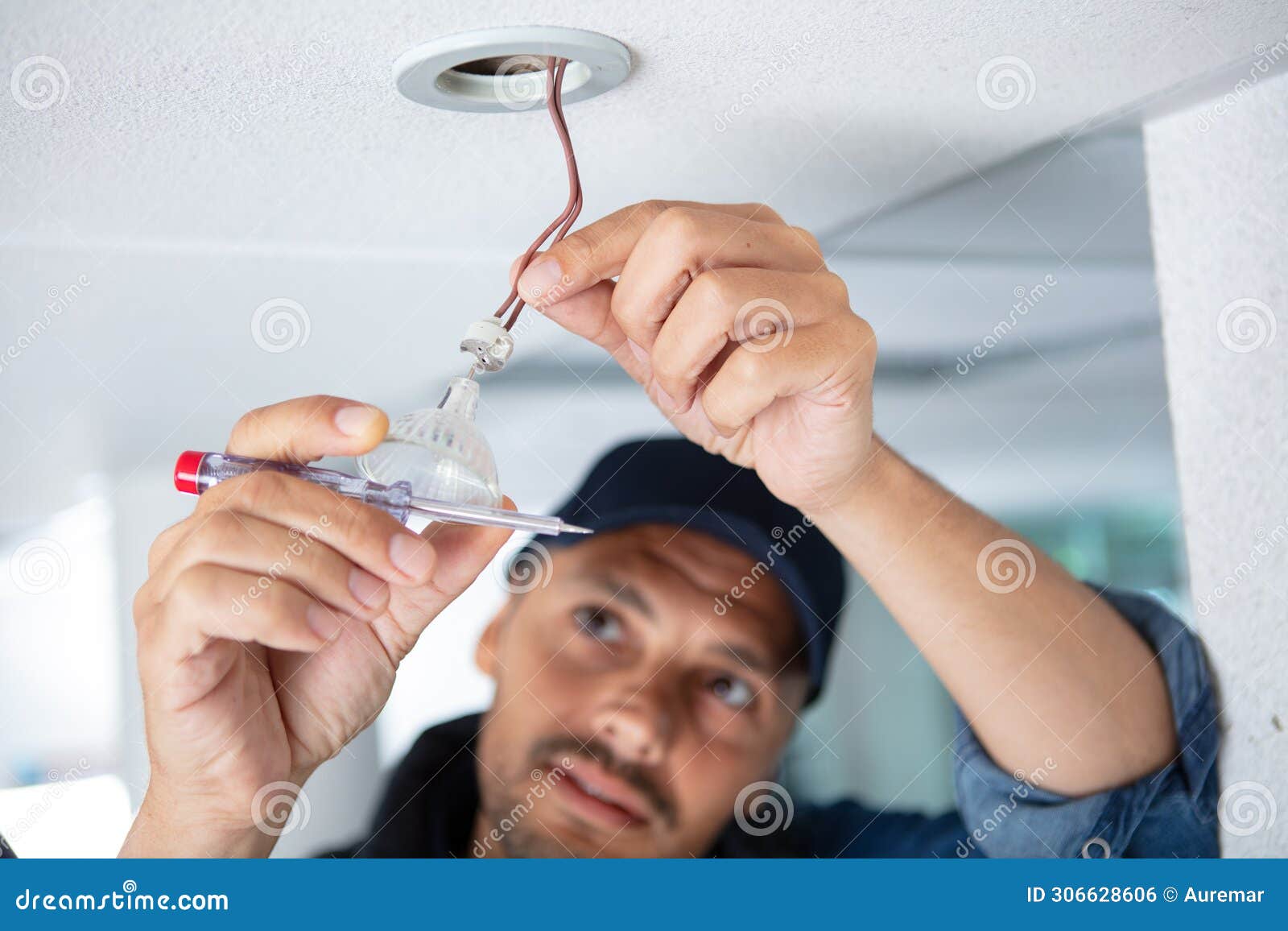 Man Fixing Spotlight To Ceiling Stock Photo - Image of indoors, home ...