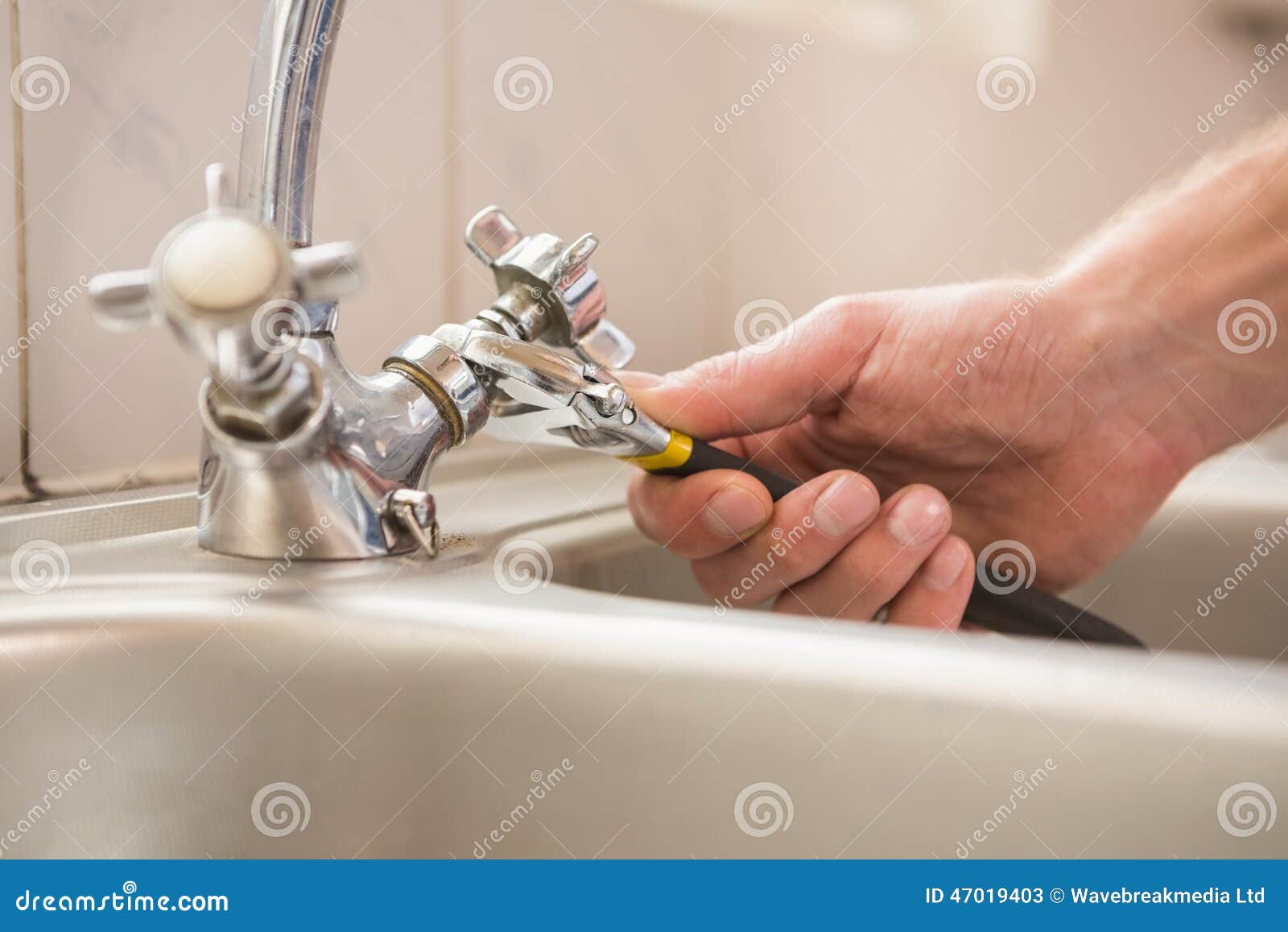Man fixing tap with pliers stock image. Image of professional - 47019403
