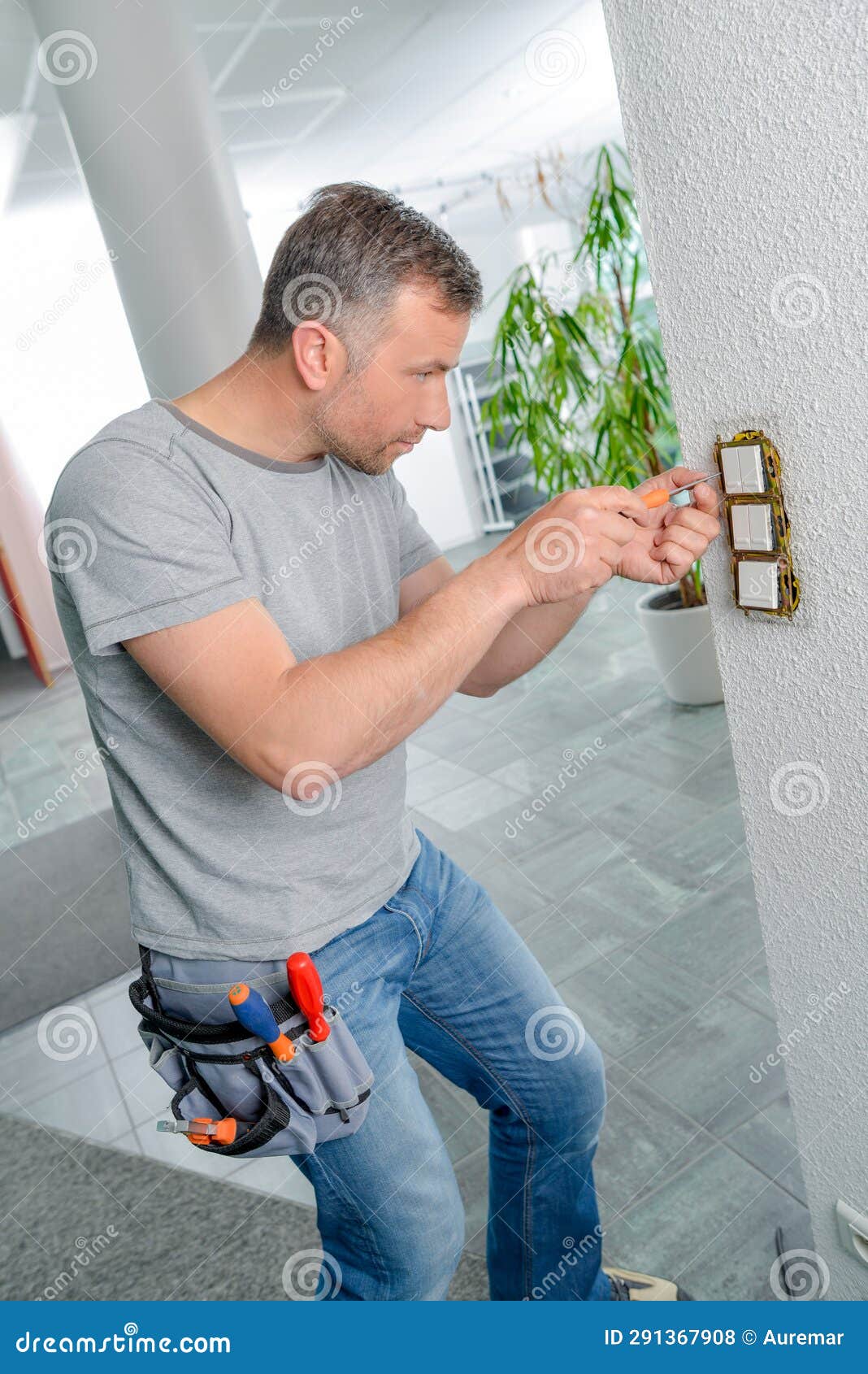Man Fixing Triple Switch To Wall Stock Photo - Image of caucasian ...