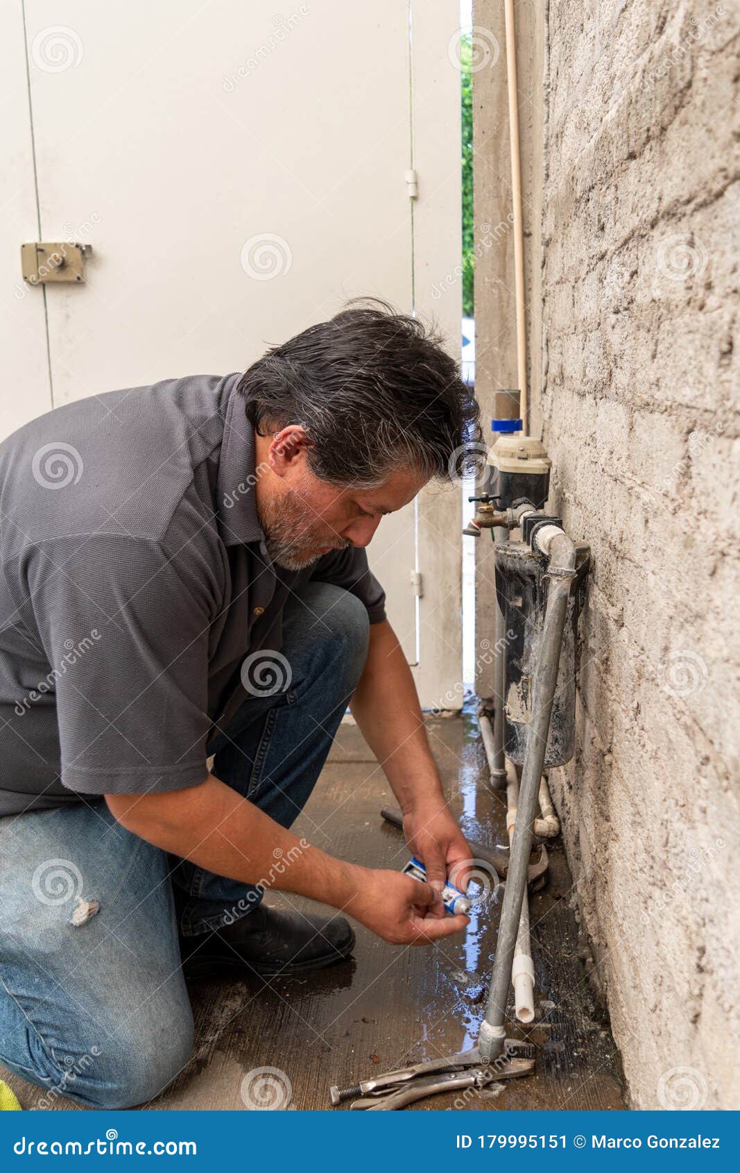 Man fixing a tube stock image. Image of equipment, house - 179995151