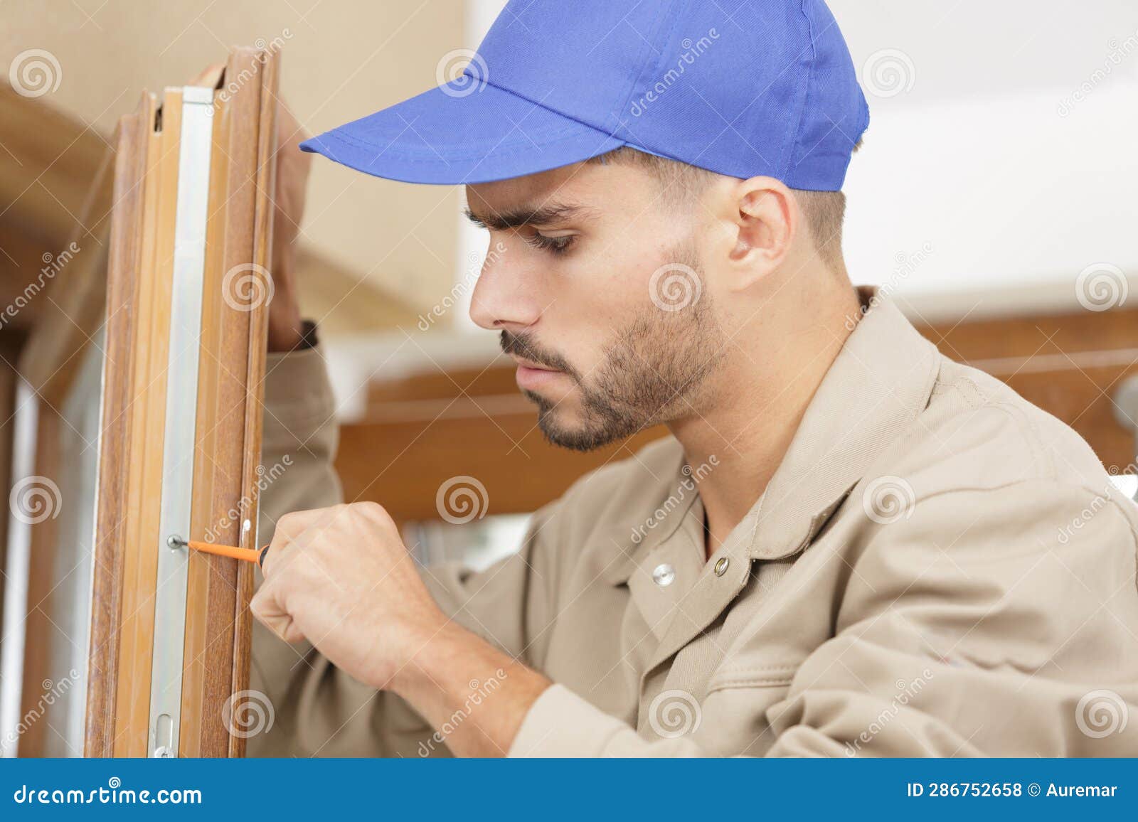 Man fixing window frame stock photo. Image of service - 286752658