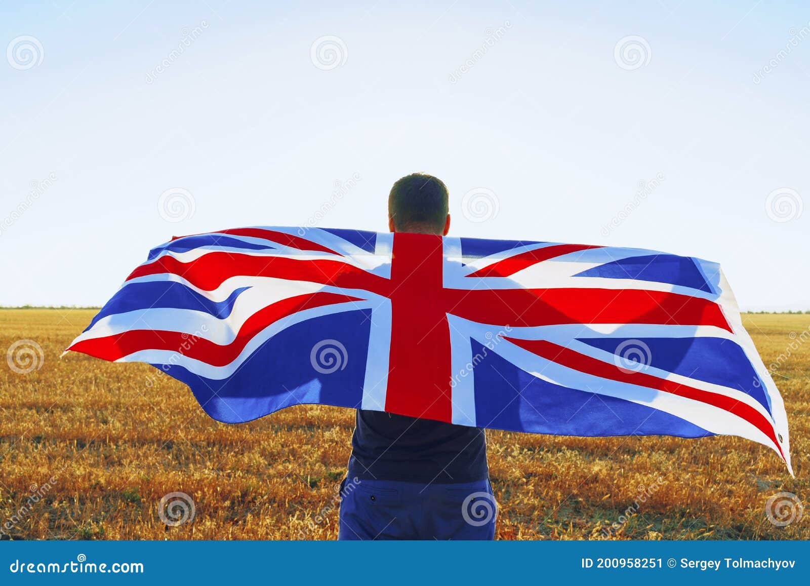 Man with a Flag of Great Britain Standing in Field Stock Image - Image ...