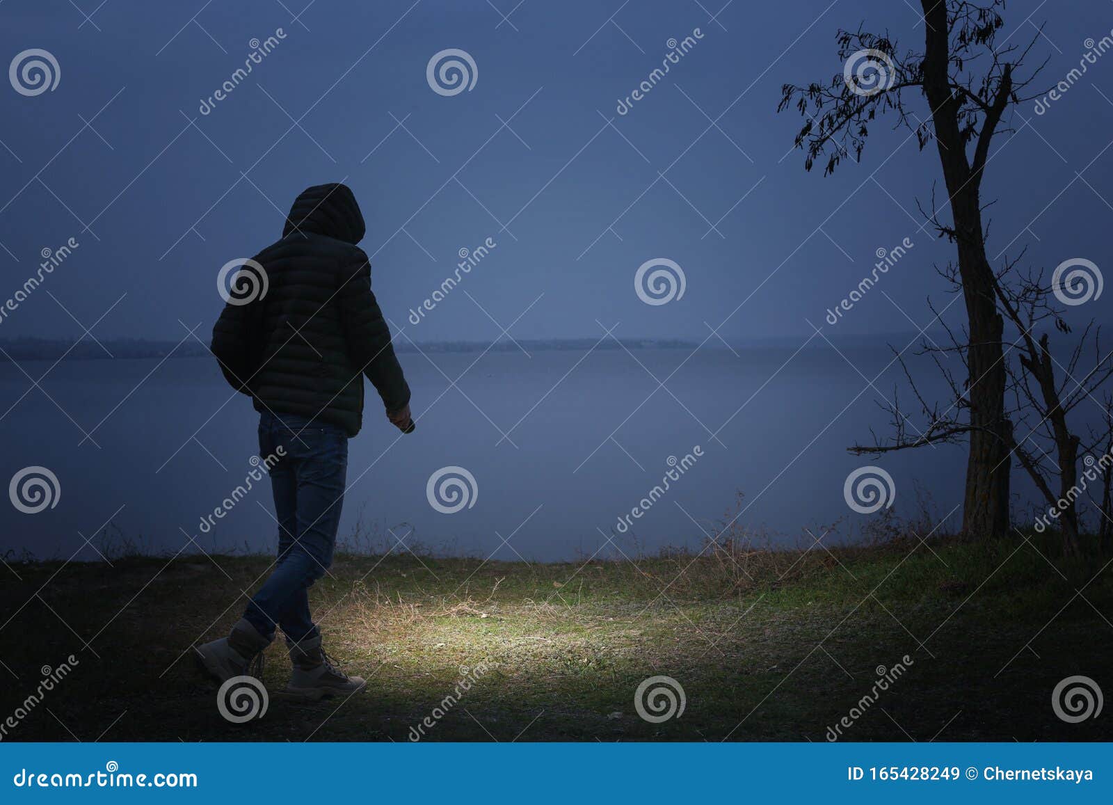 Man with Flashlight Walking Near River Stock Image - Image of equipment ...