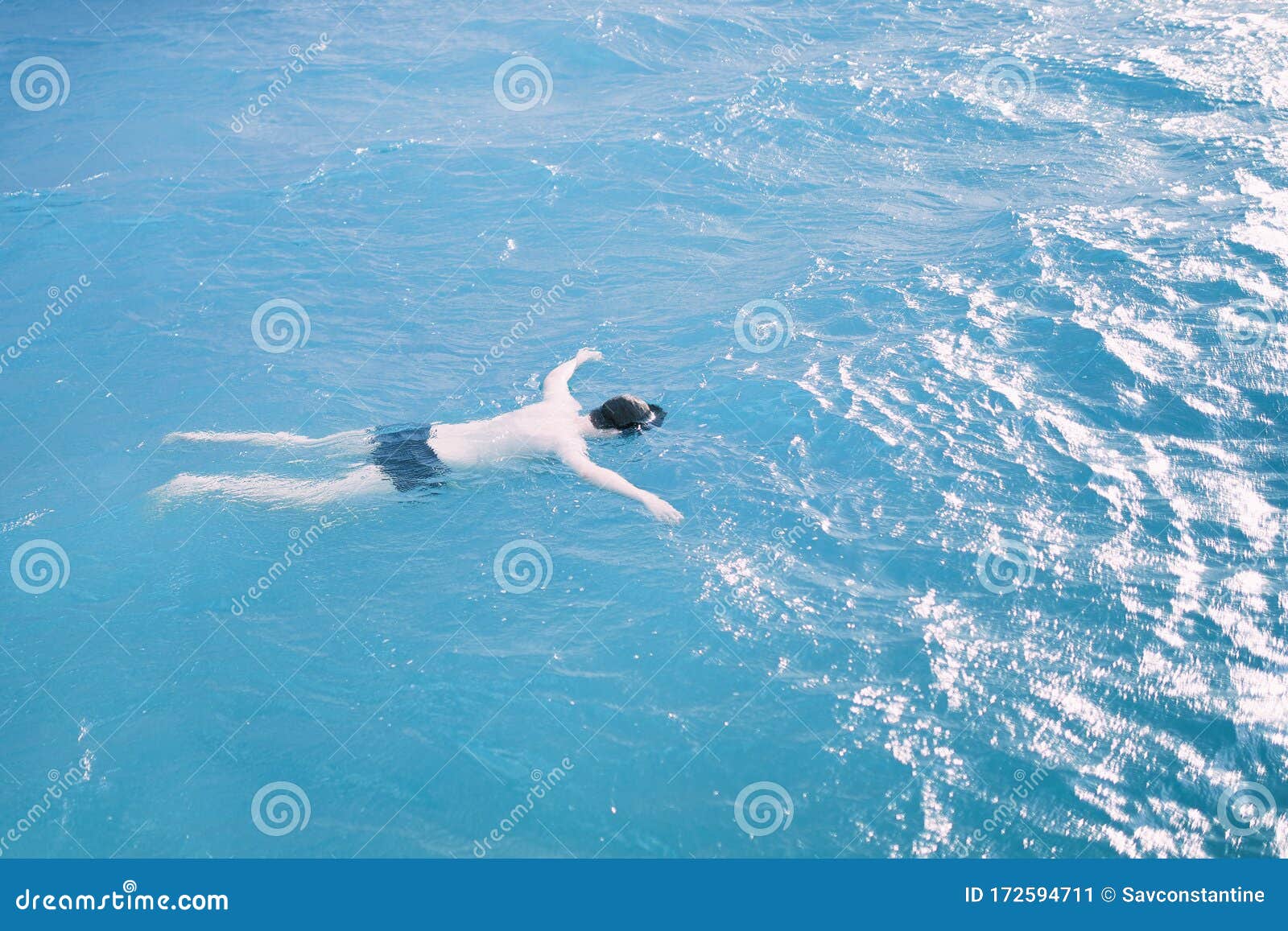 Man floating in the ocean stock image. Image of people - 172594711