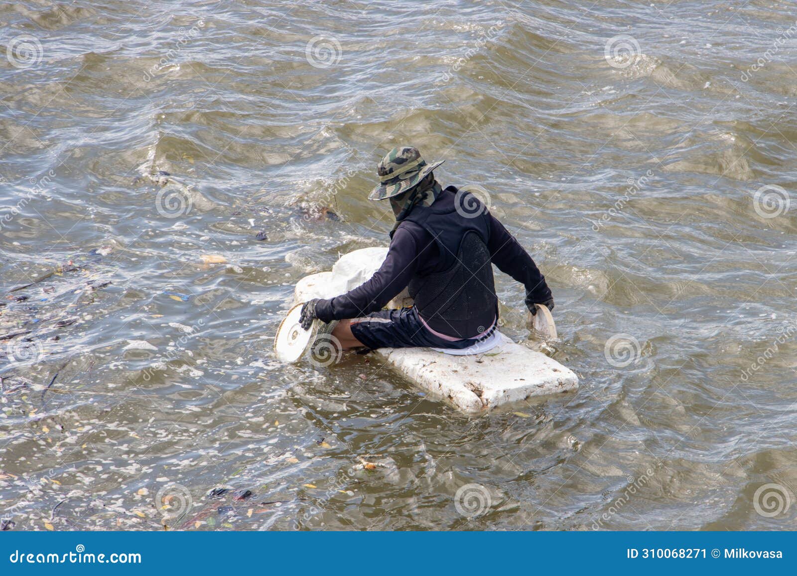 A Man Floating on a Polystyrene and Used a Lids for Paddled Stock Image ...
