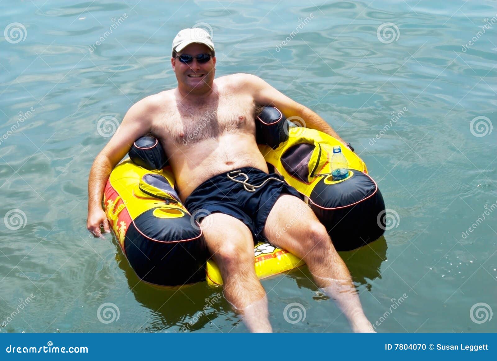 Man Floating In Water/Tube Stock Photo - Image: 7804070