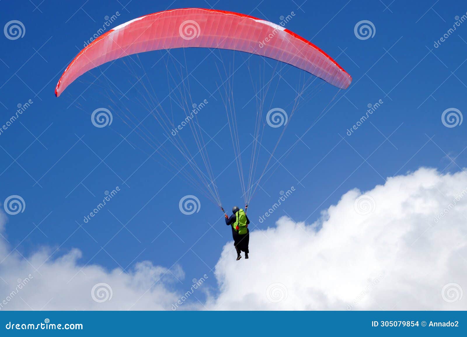 Man Flying on a Parachute Wing with a Blue Sky Stock Photo - Image of ...
