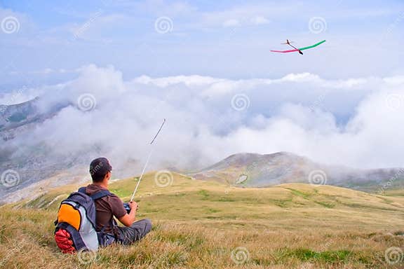 Man Flying a Plane from a Top of the Mountain Stock Image - Image of ...