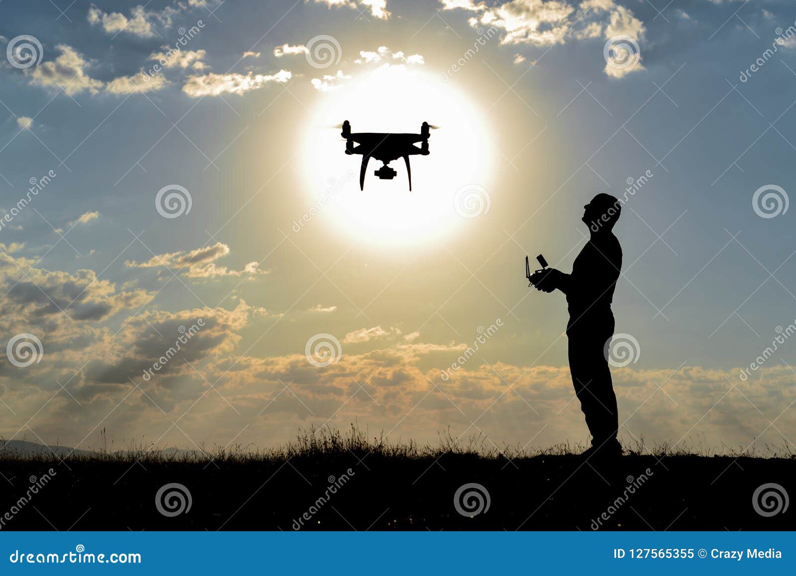 Man flying quadcopter stock image. Image of silhouette - 127565355