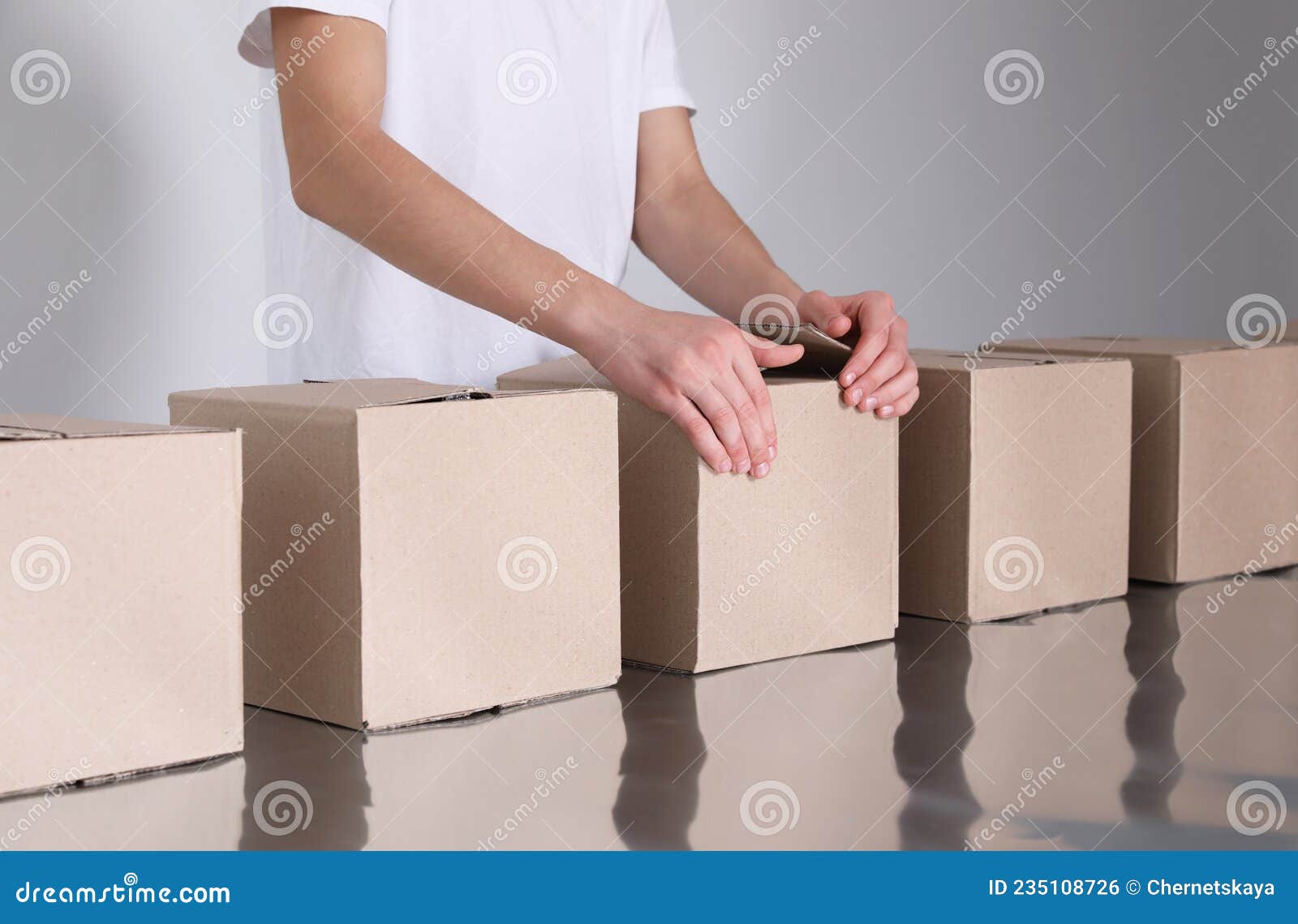 Man Folding Cardboard Boxes at Table, Closeup. Production Line Stock ...