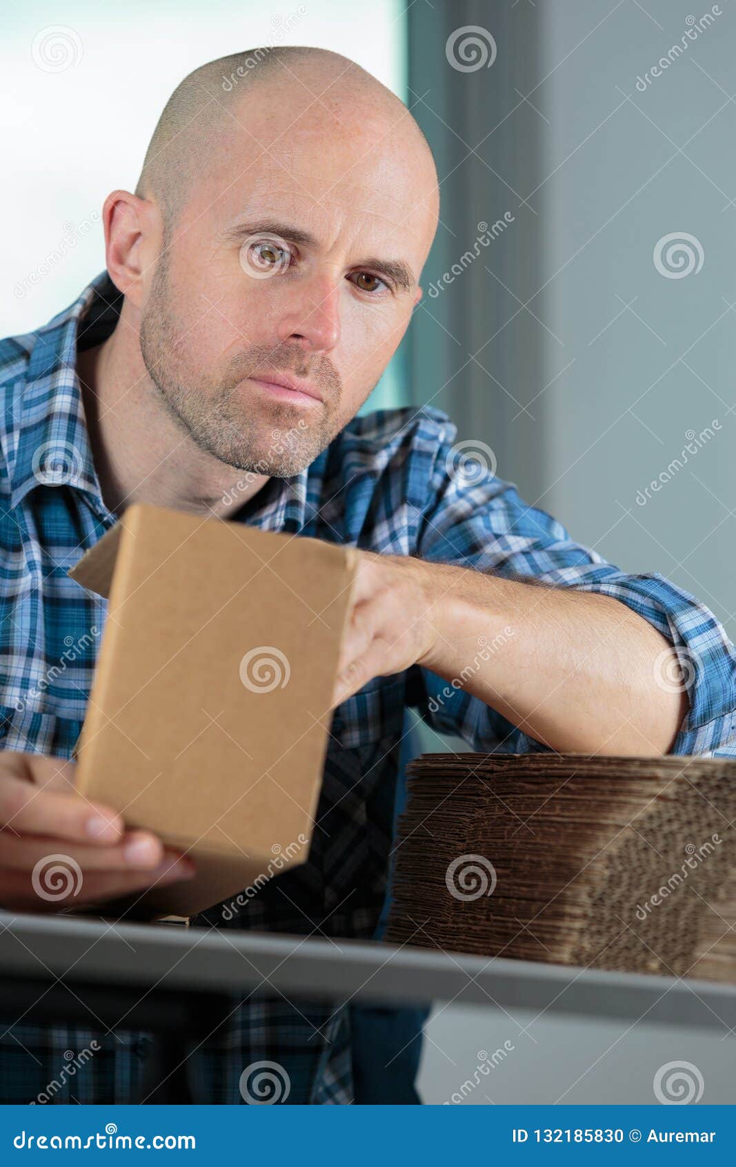 Man Folding Cardboard into Packaging Stock Photo - Image of board ...