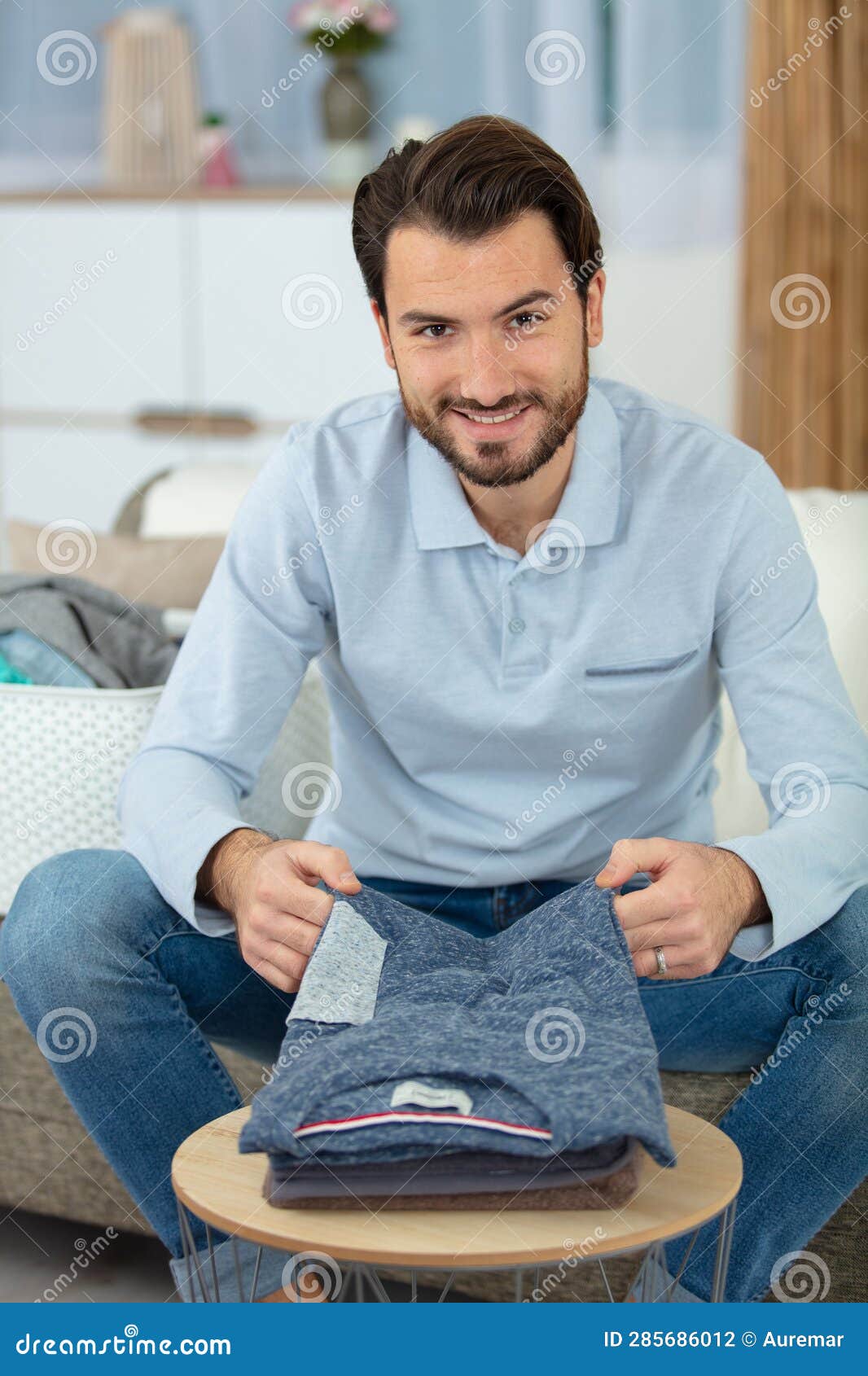 Man Folding Laundry in Home Stock Photo - Image of home, ironed: 285686012