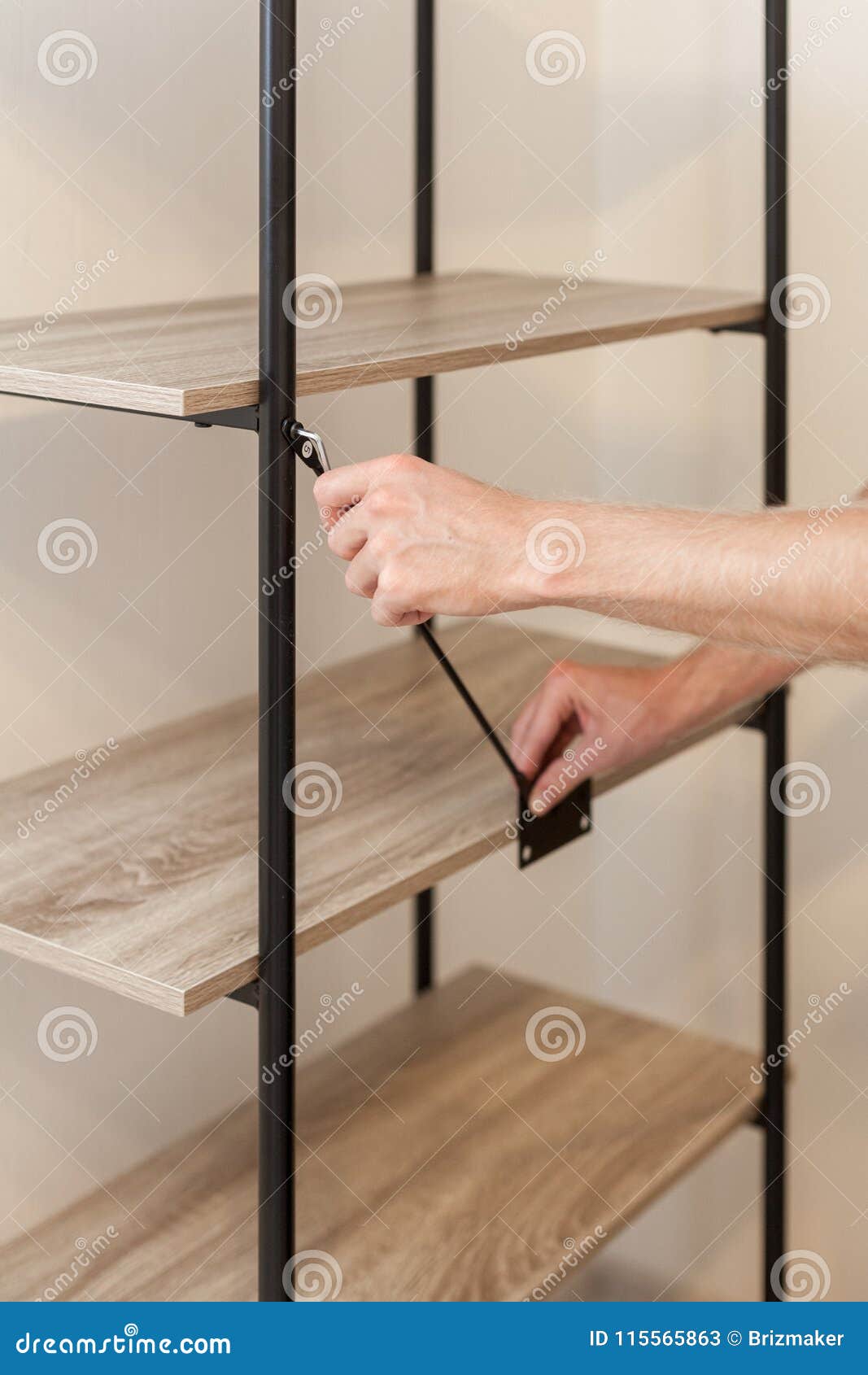 The Man Folds the Bookcase Connecting the Rails of the Shelves Stock ...