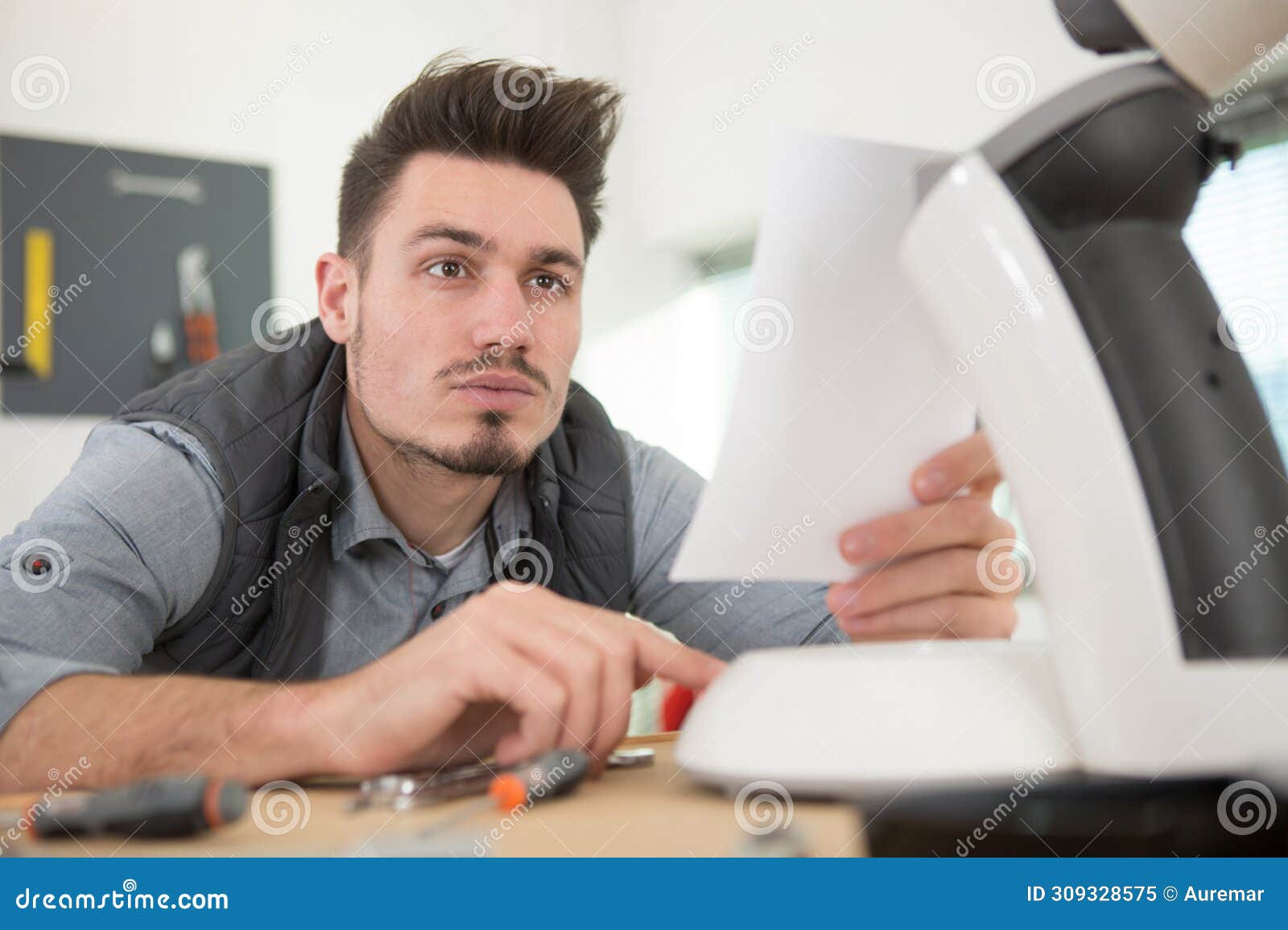 Man Following Instructions To Programme Electrical Appliance Stock ...