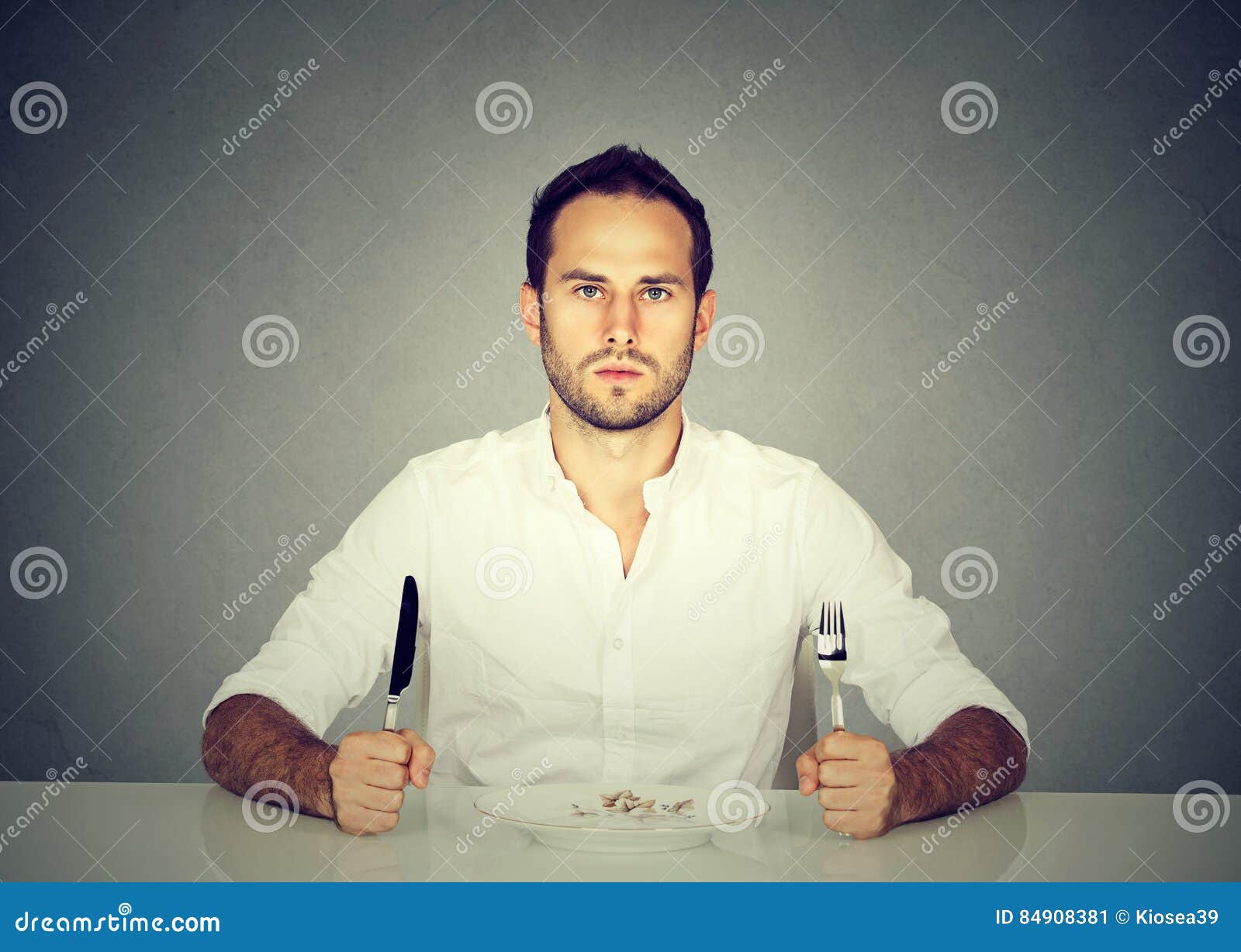 Man with Fork and Knife Sitting at Table with Empty Plate Stock Image ...